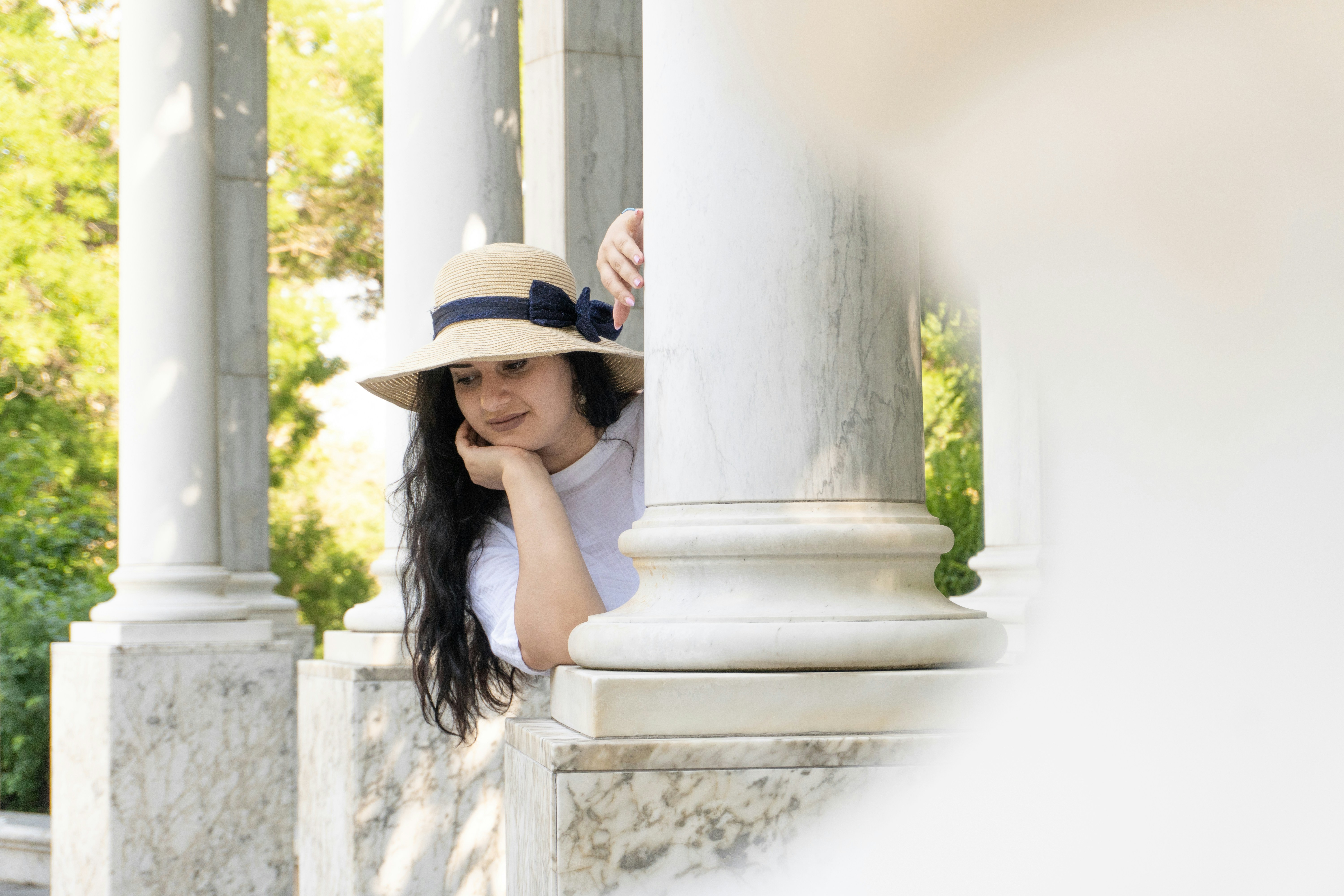 Portrait through Marble Columns: A Quiet Moment in the Pavilion