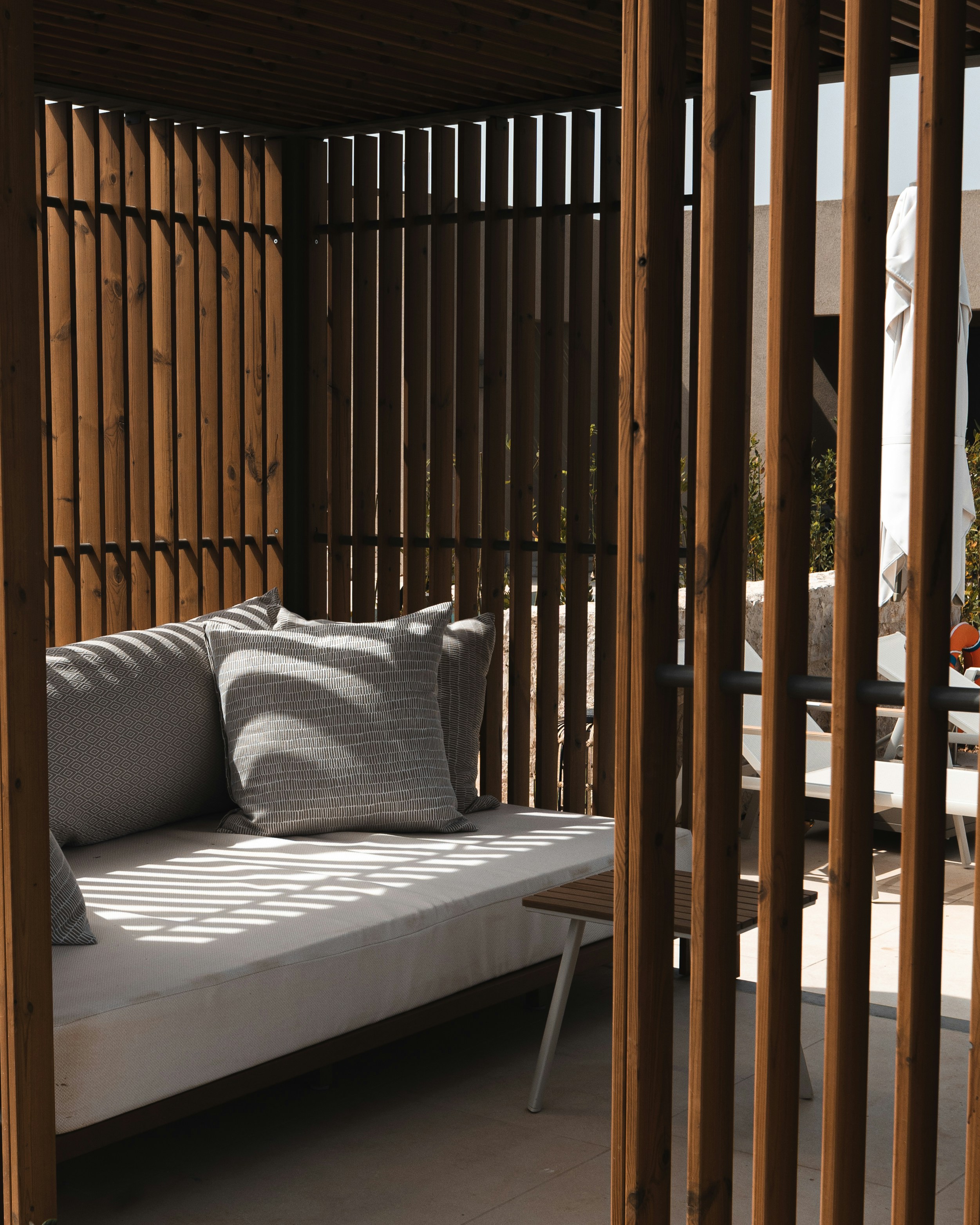 Shaded Lounge Oasis Beneath Slatted Wood Canopy