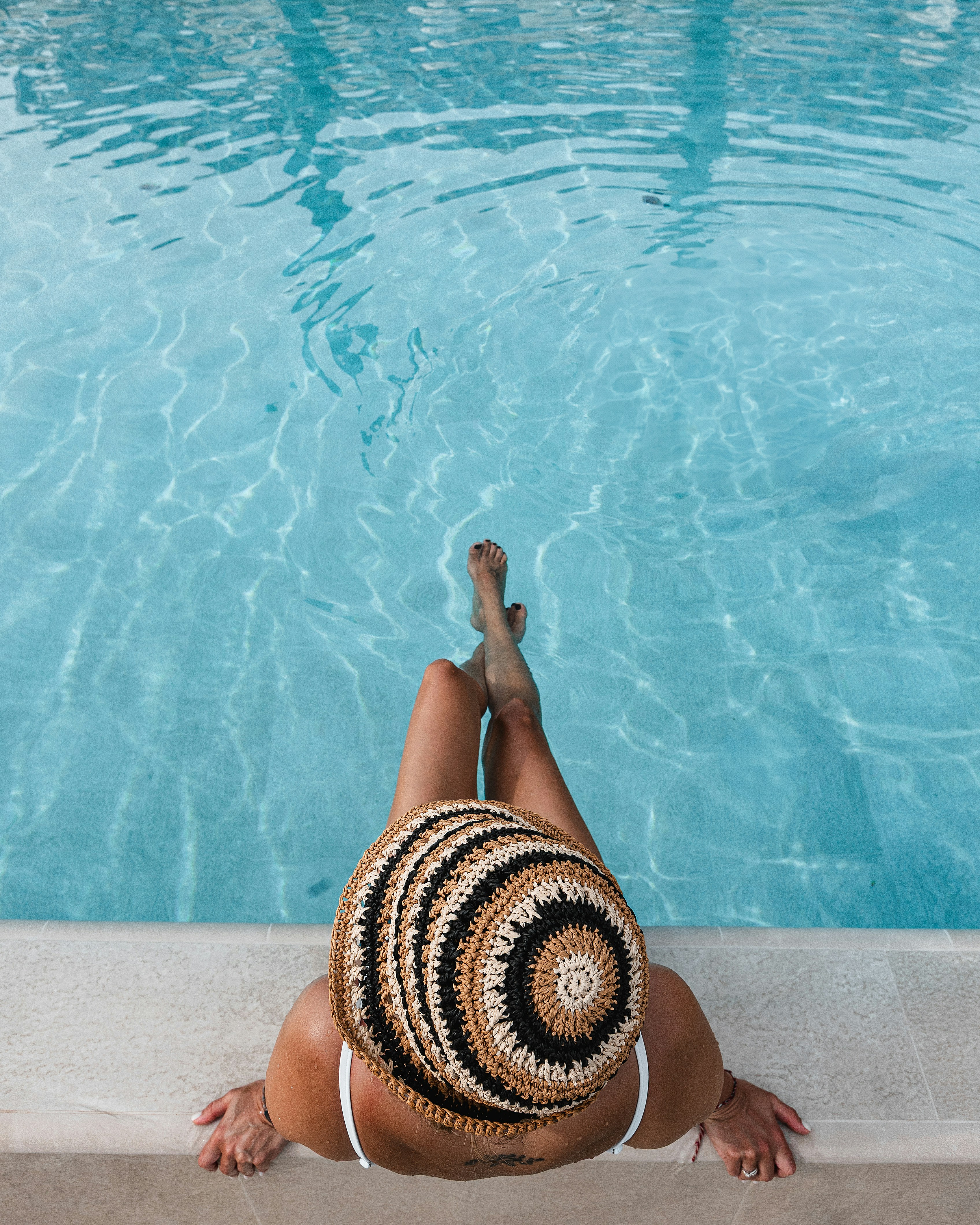 Straw-hatted stillness over turquoise water