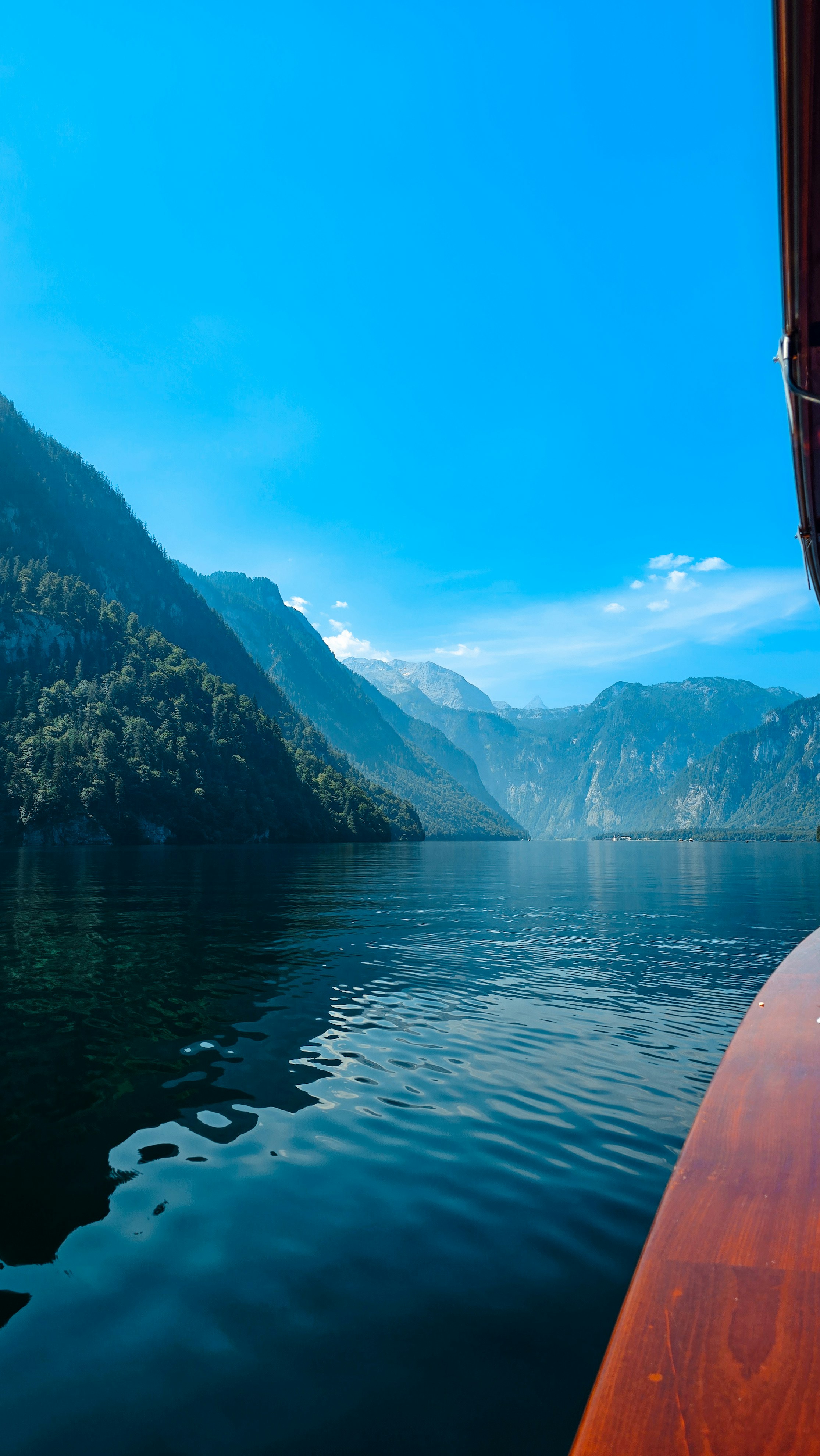 Boat Shown from Rail Window as Fjord Mountains Unfold