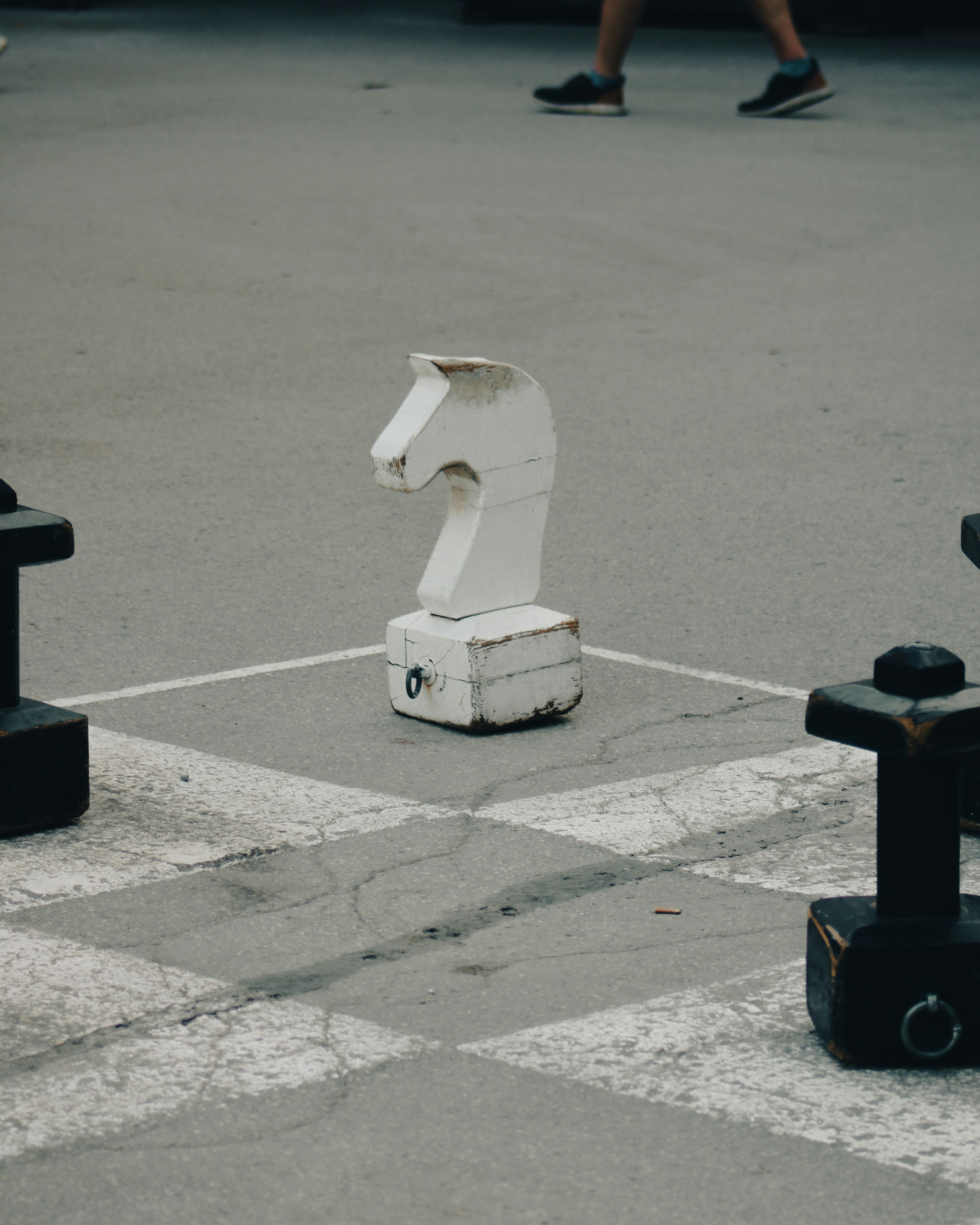 Weathered Chess Piece Guards the Parking Lot Line