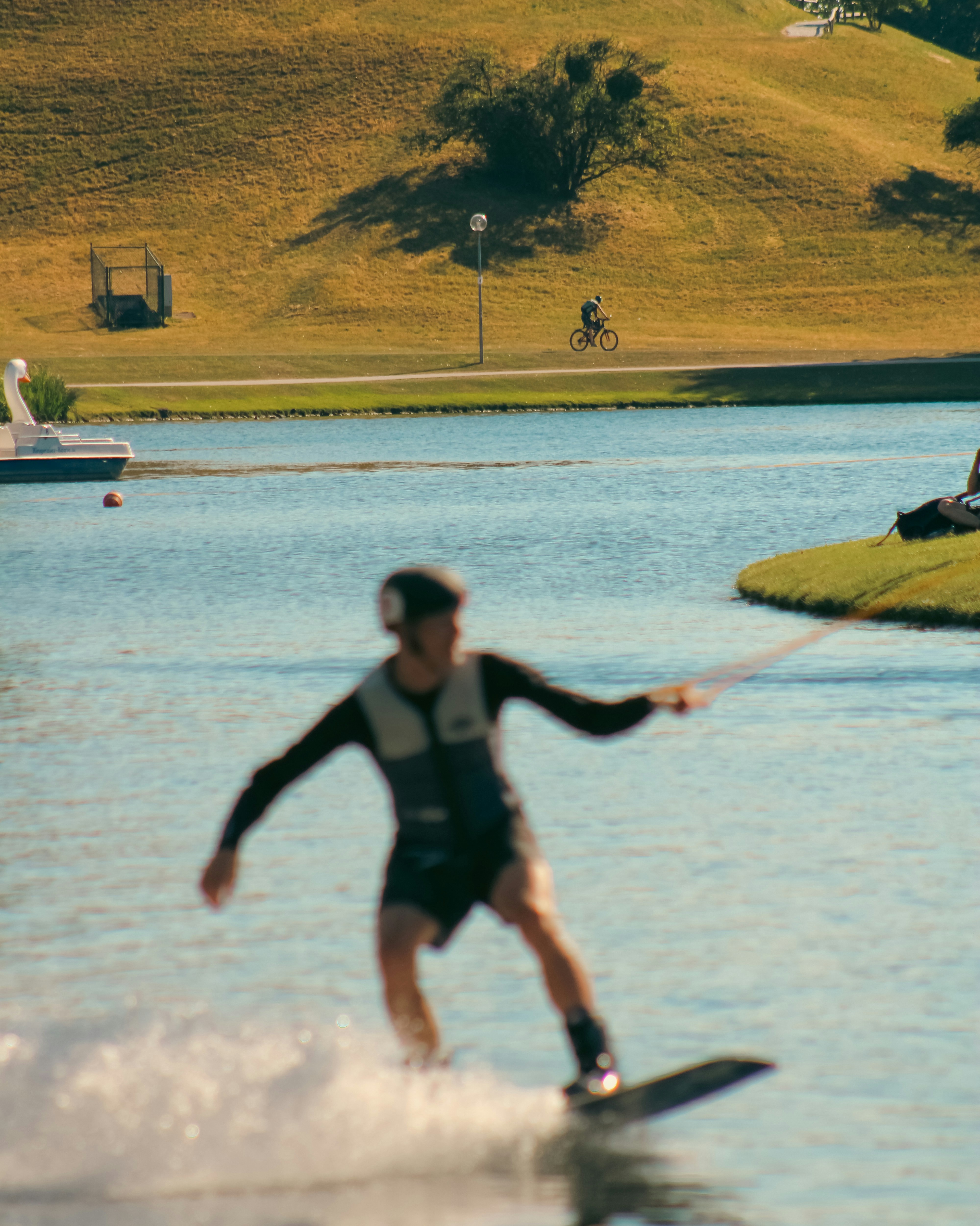 Balanced Blur: Cyclist on the Park’s Shoreline