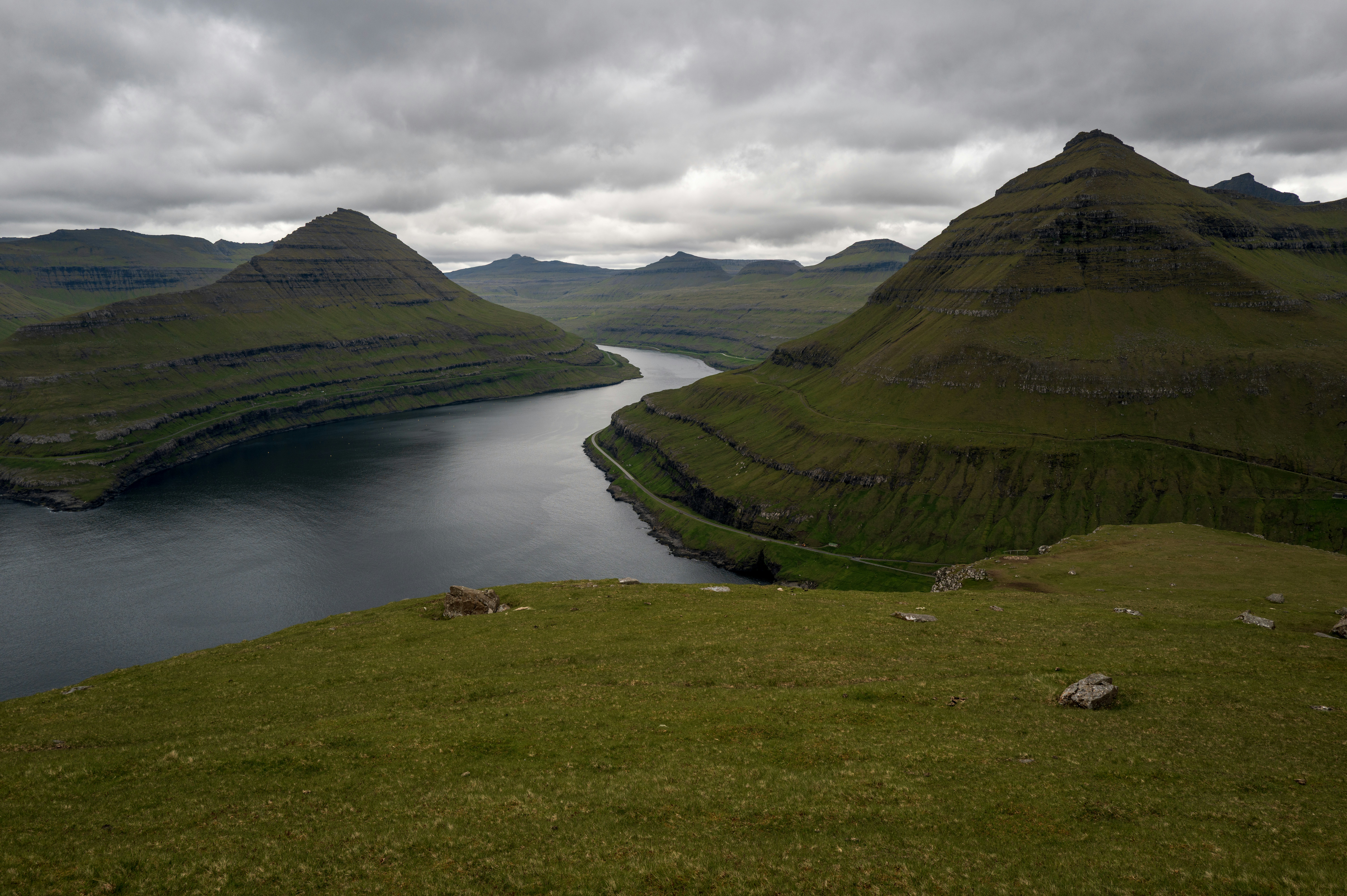 River-meandered Highlands under a Brooding Sky