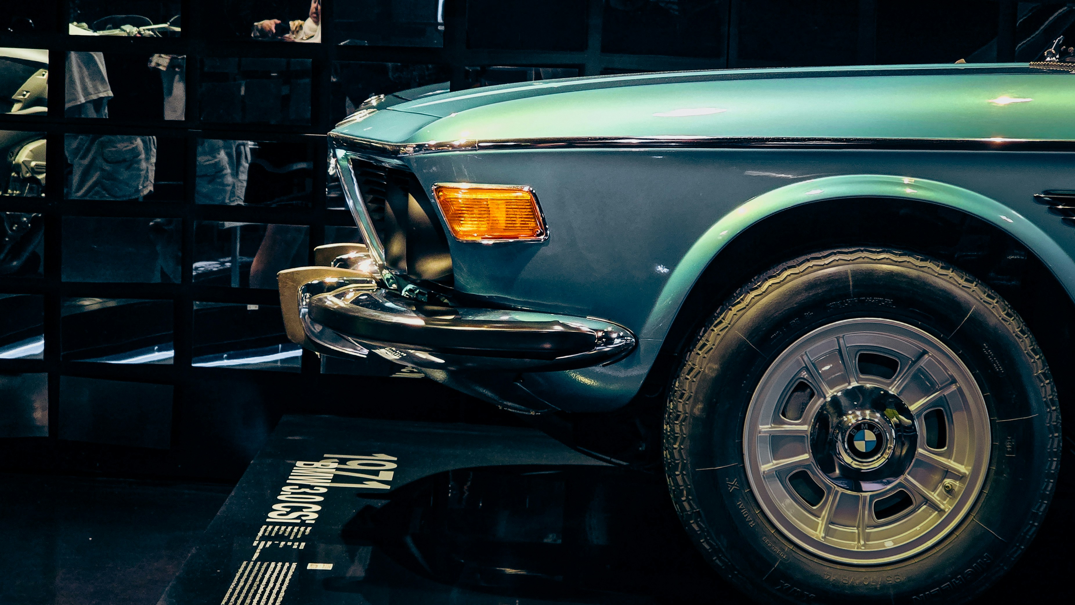 Classic Car Loupe: A Mint-Turquoise Front Quarter Under Exhibition Lights