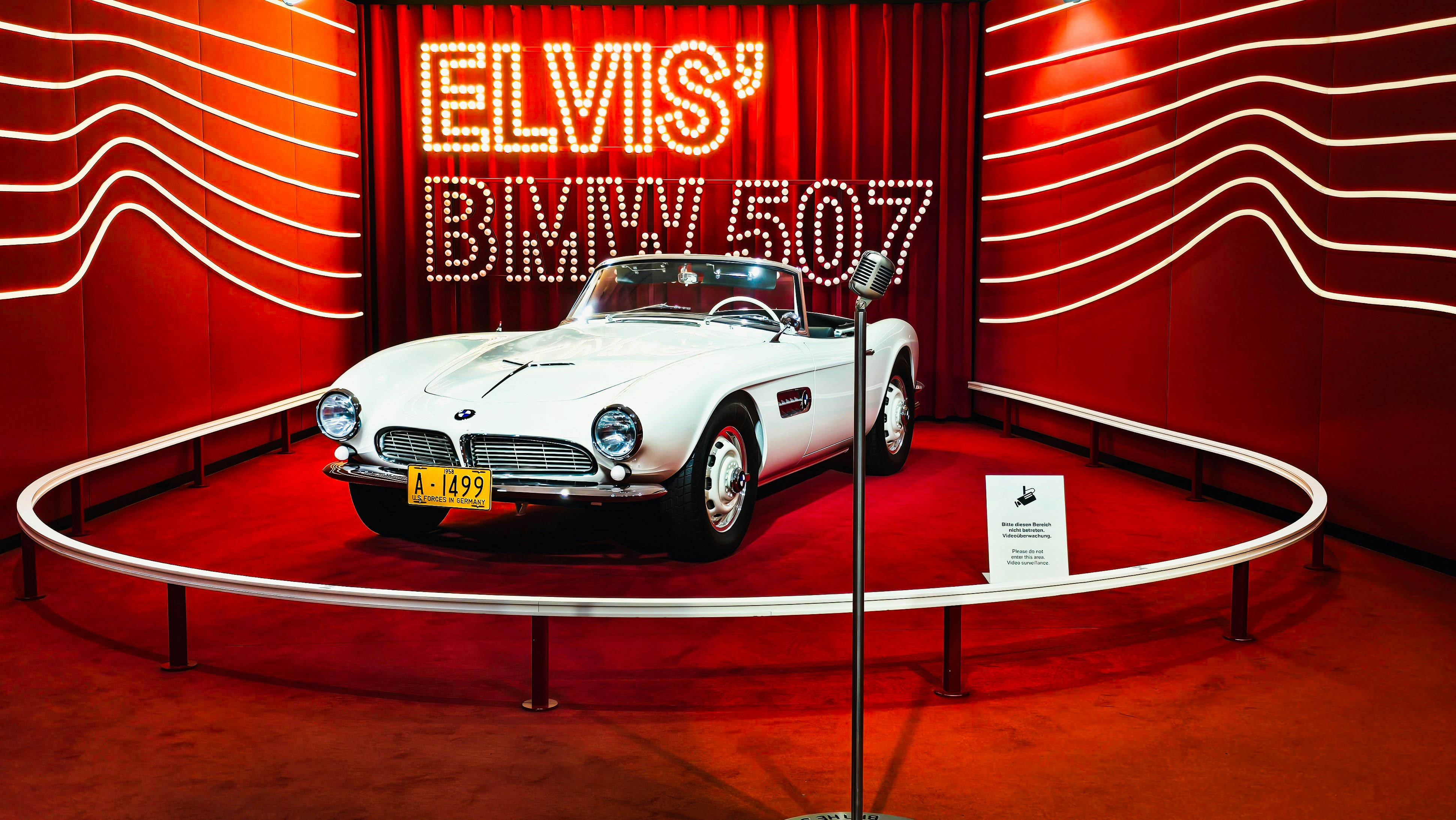 Elvis’ Convertible: A White Triumph Under Neon Waves