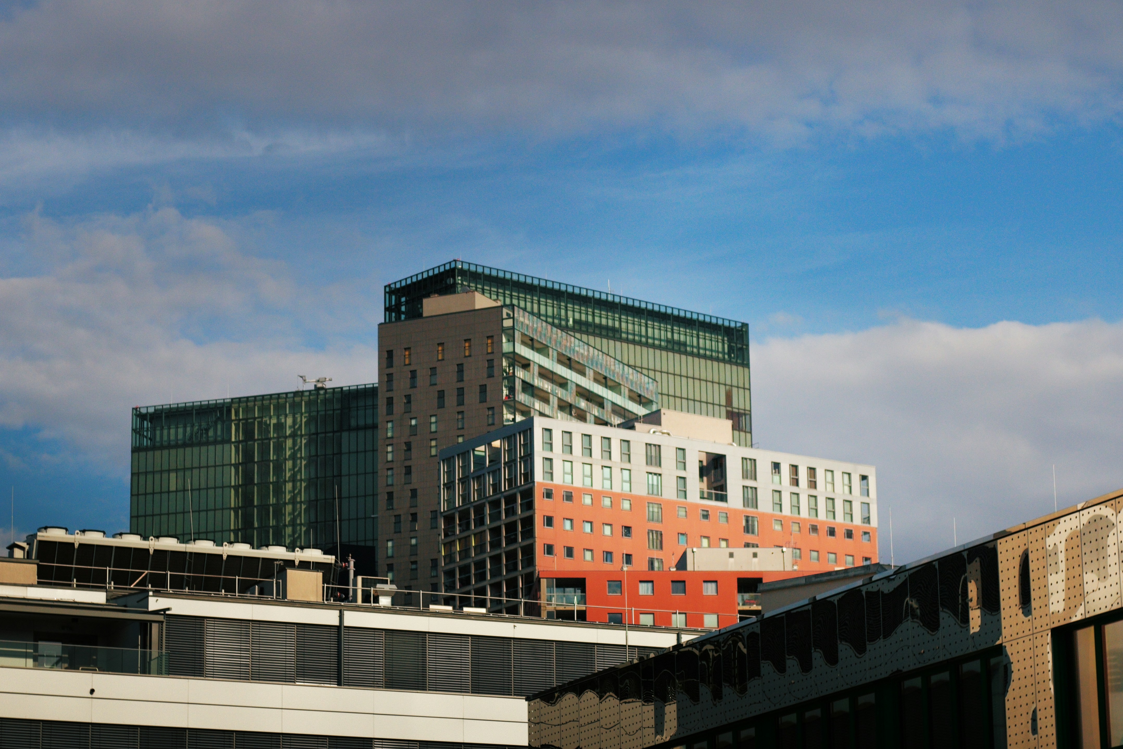 Stacked Modernity: A Rooftop Mosaic of Glass and Brick