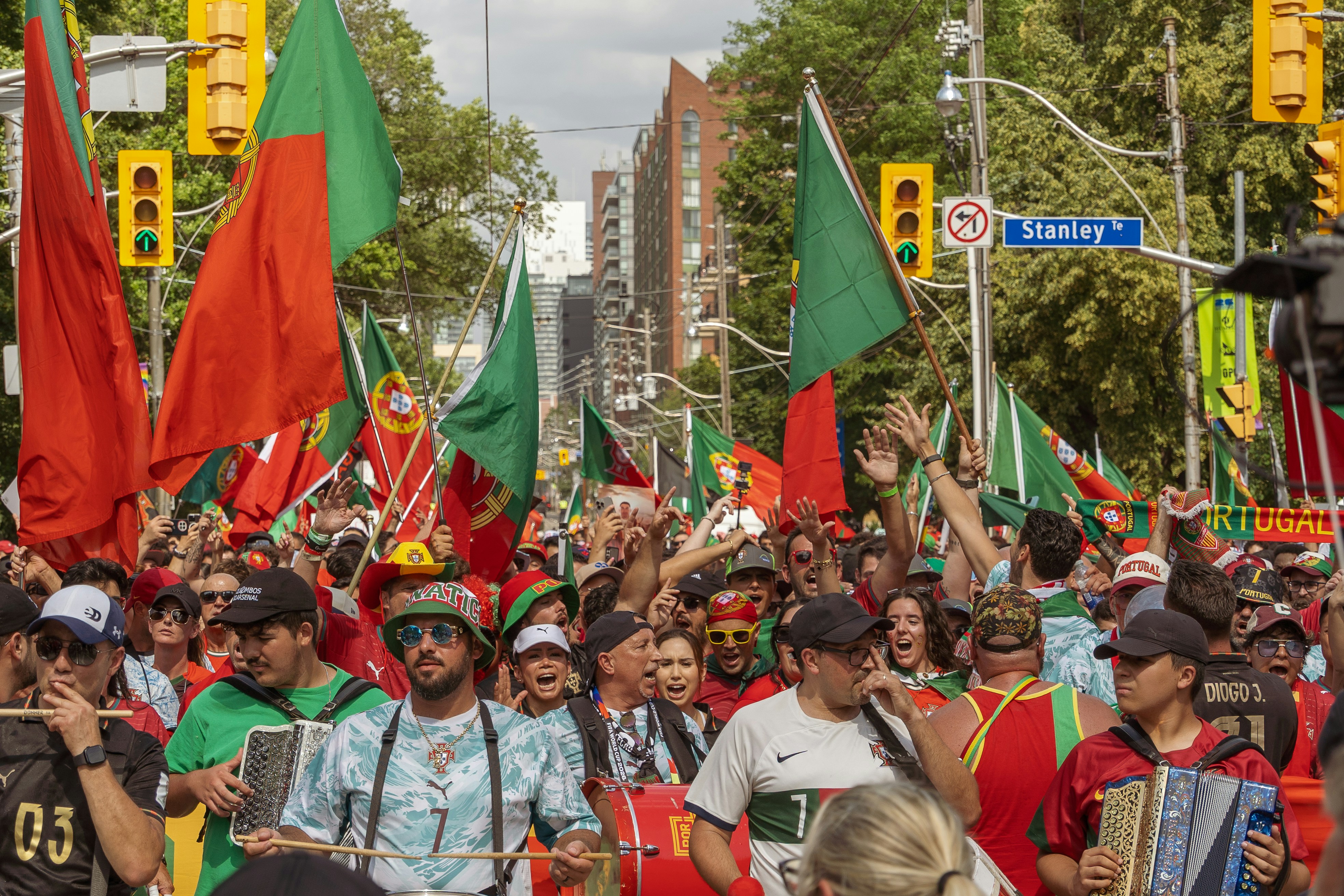 Vibrant Street Parade: Flags, Drums, and Roaring Crowd