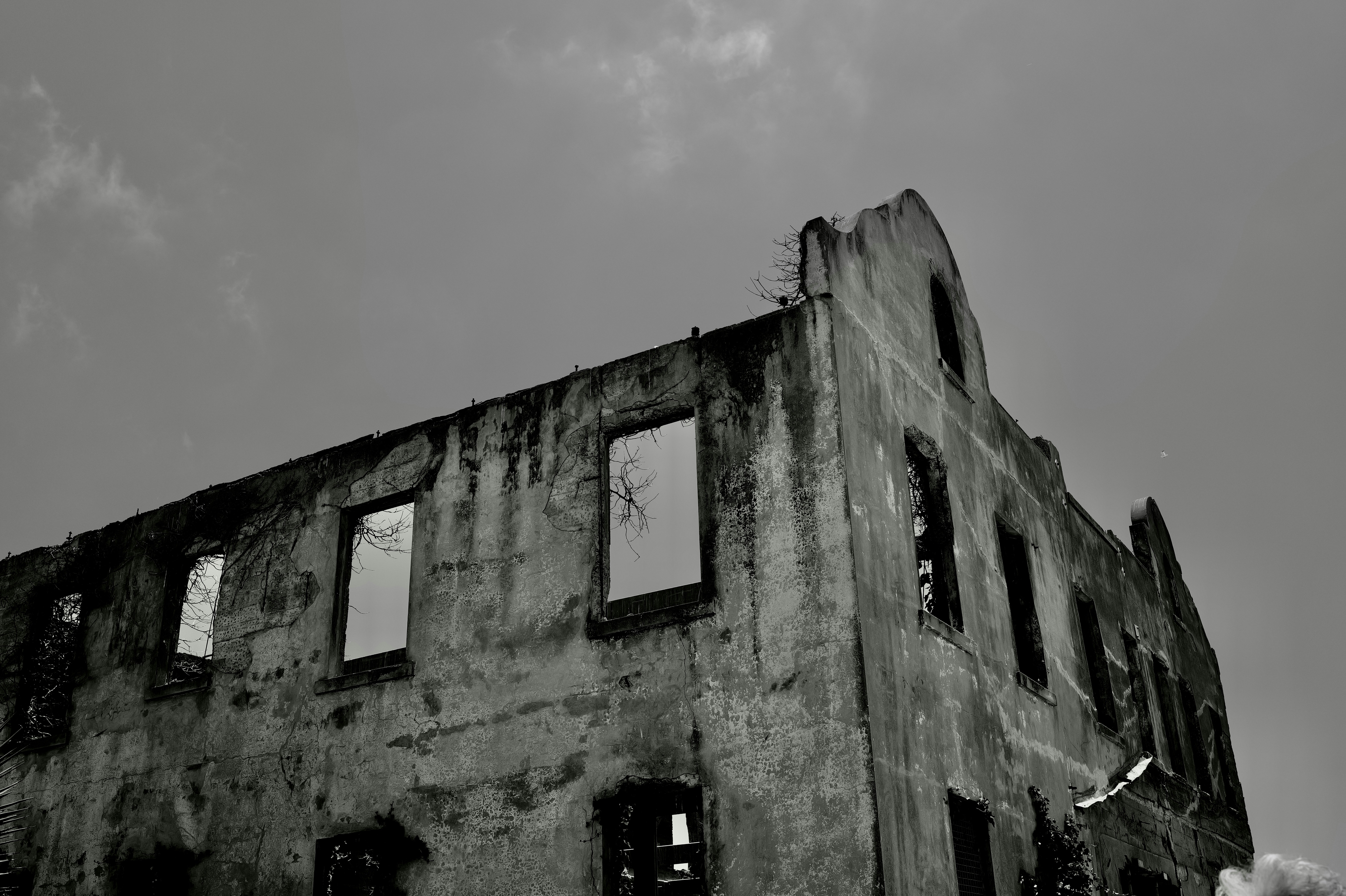 Ruined Facade: A Ghostly Gable against A Cloudless Sky