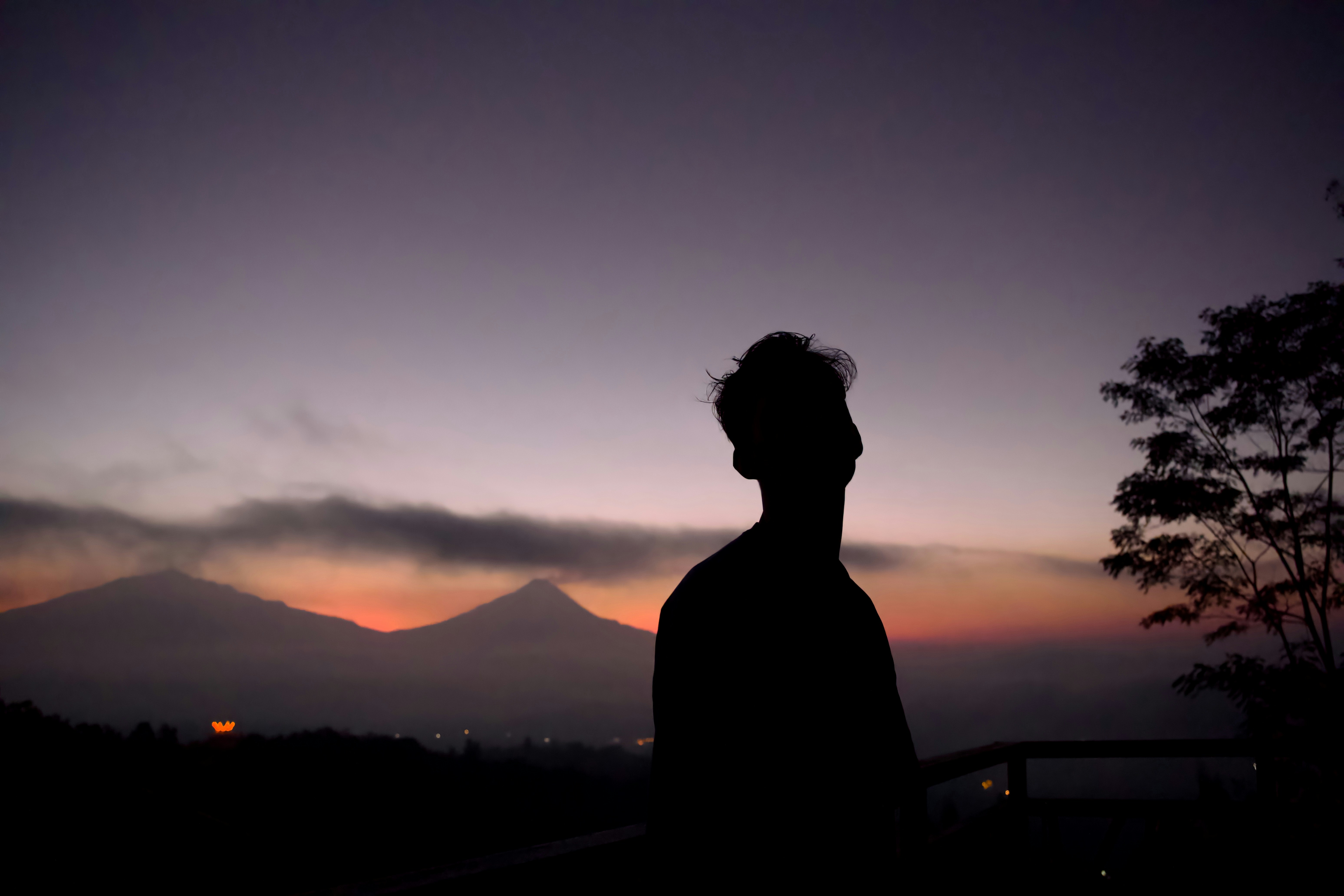 Silhouette at Dusk Before a Quiet Volcano Horizon