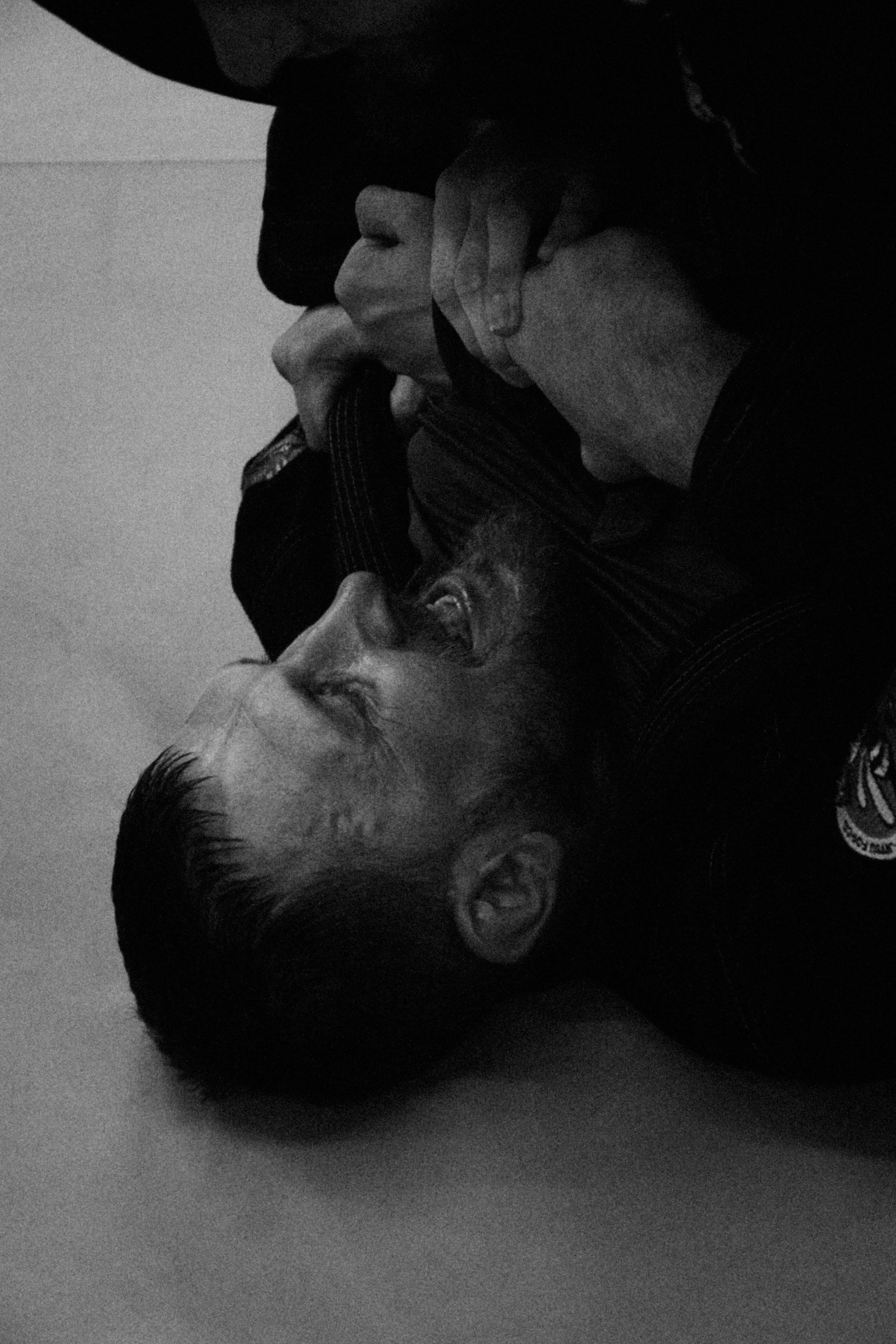 Handshake in Shadow: A Quiet Moment on the Mat