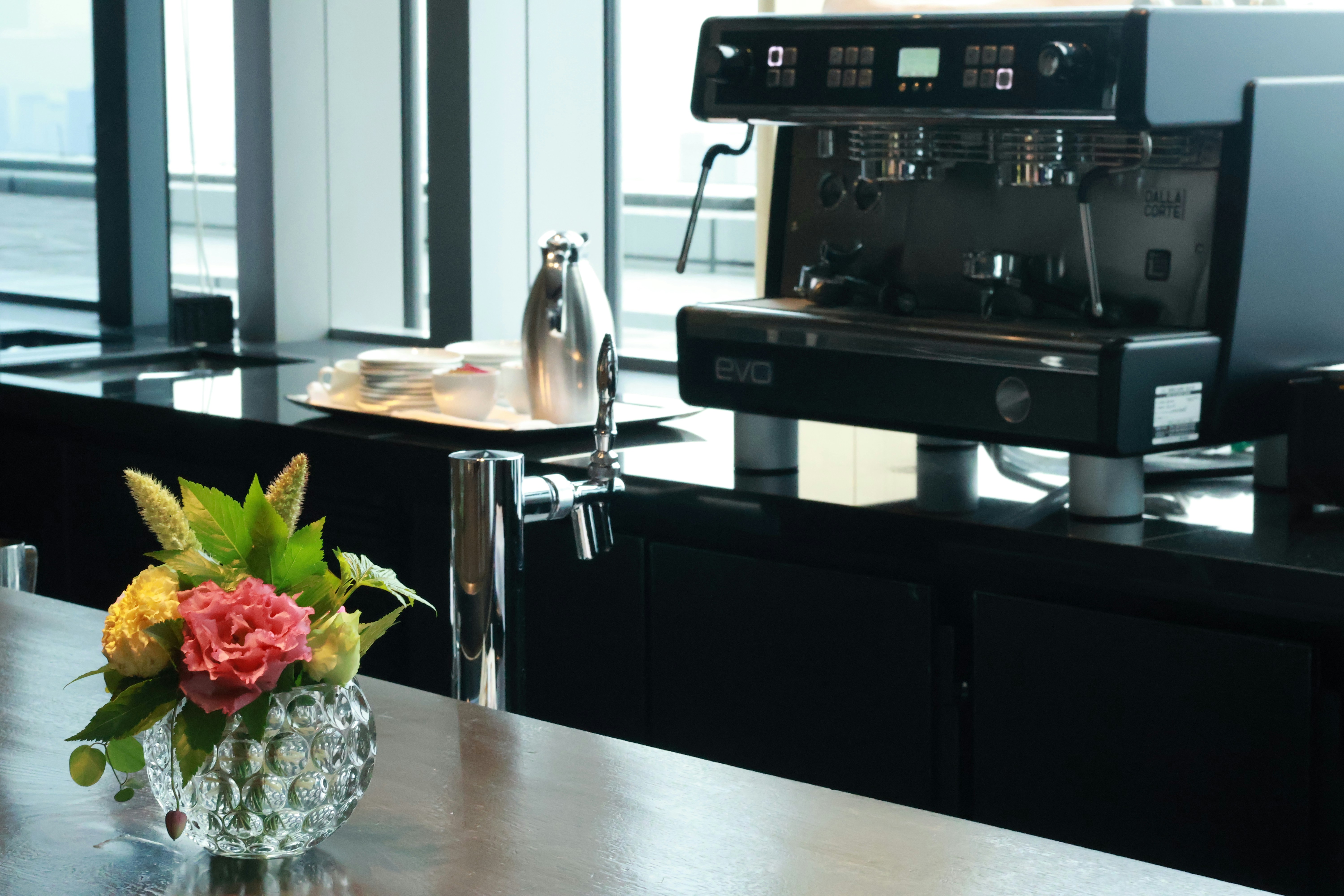 A Quiet Bar at Dusk: Fresh Flowers and an Espresso Oasis