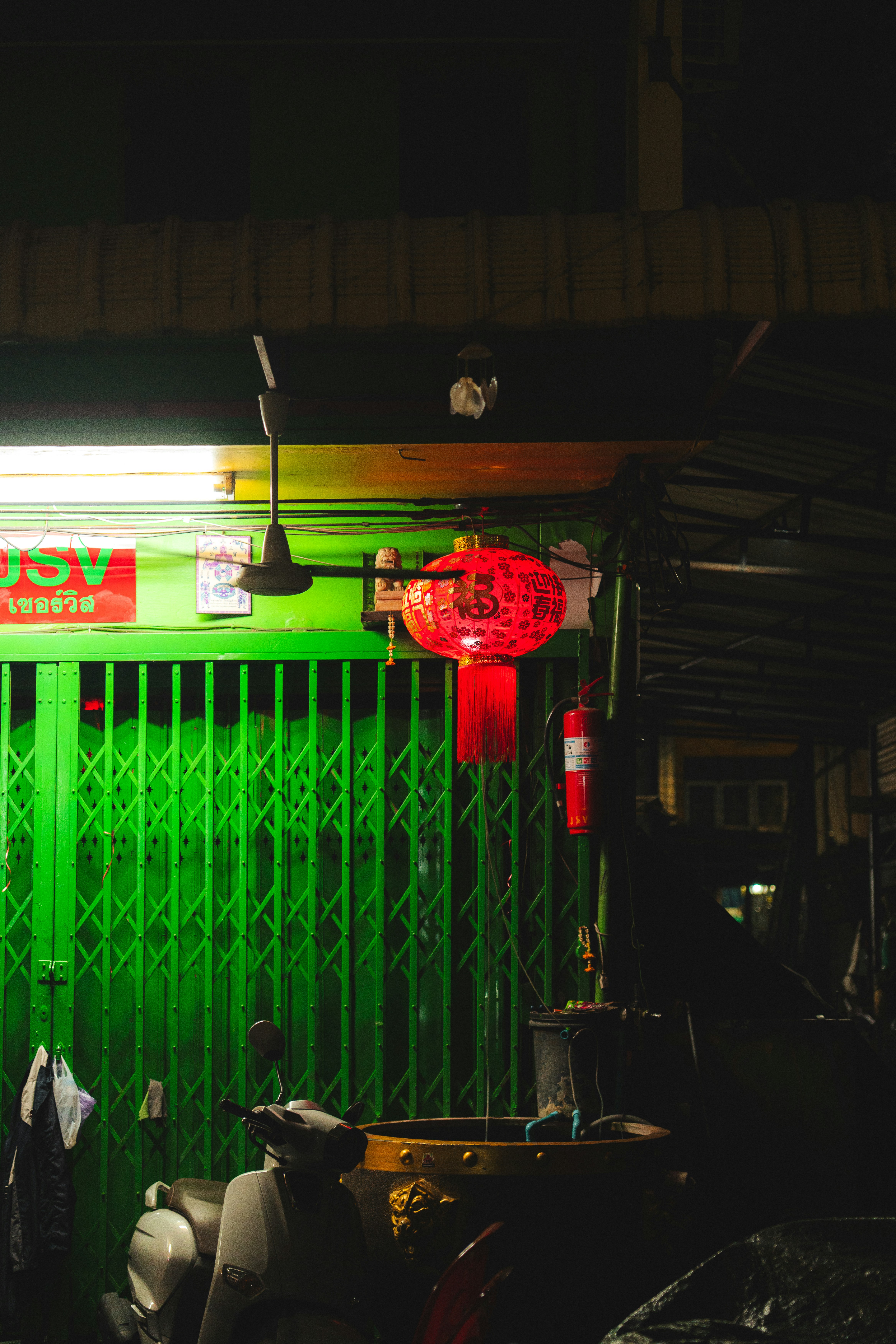 Neon Green Facade and Red Lantern at Night Market Gate