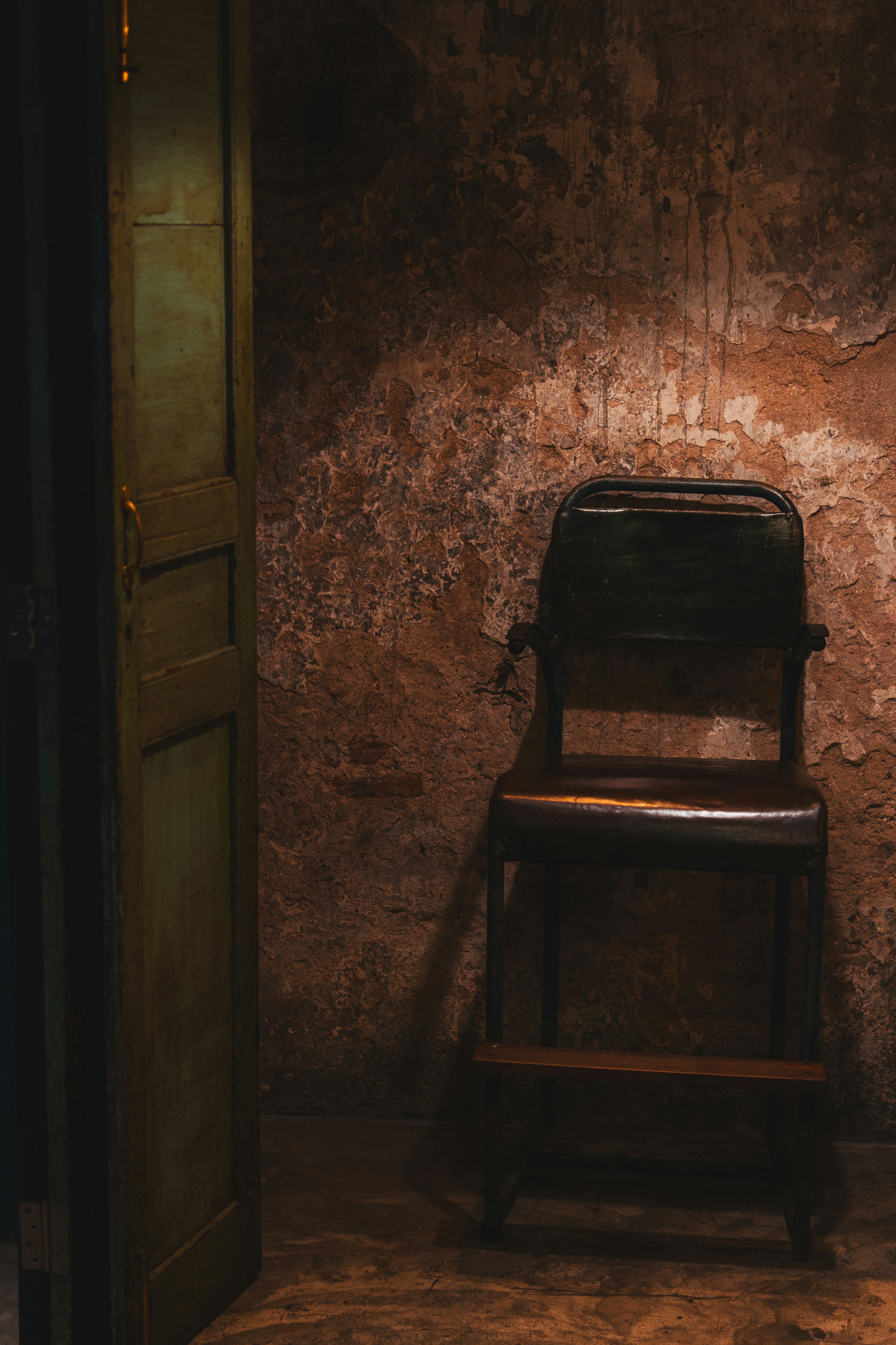 Abandoned Chair in a Dim, Crumbling Hall