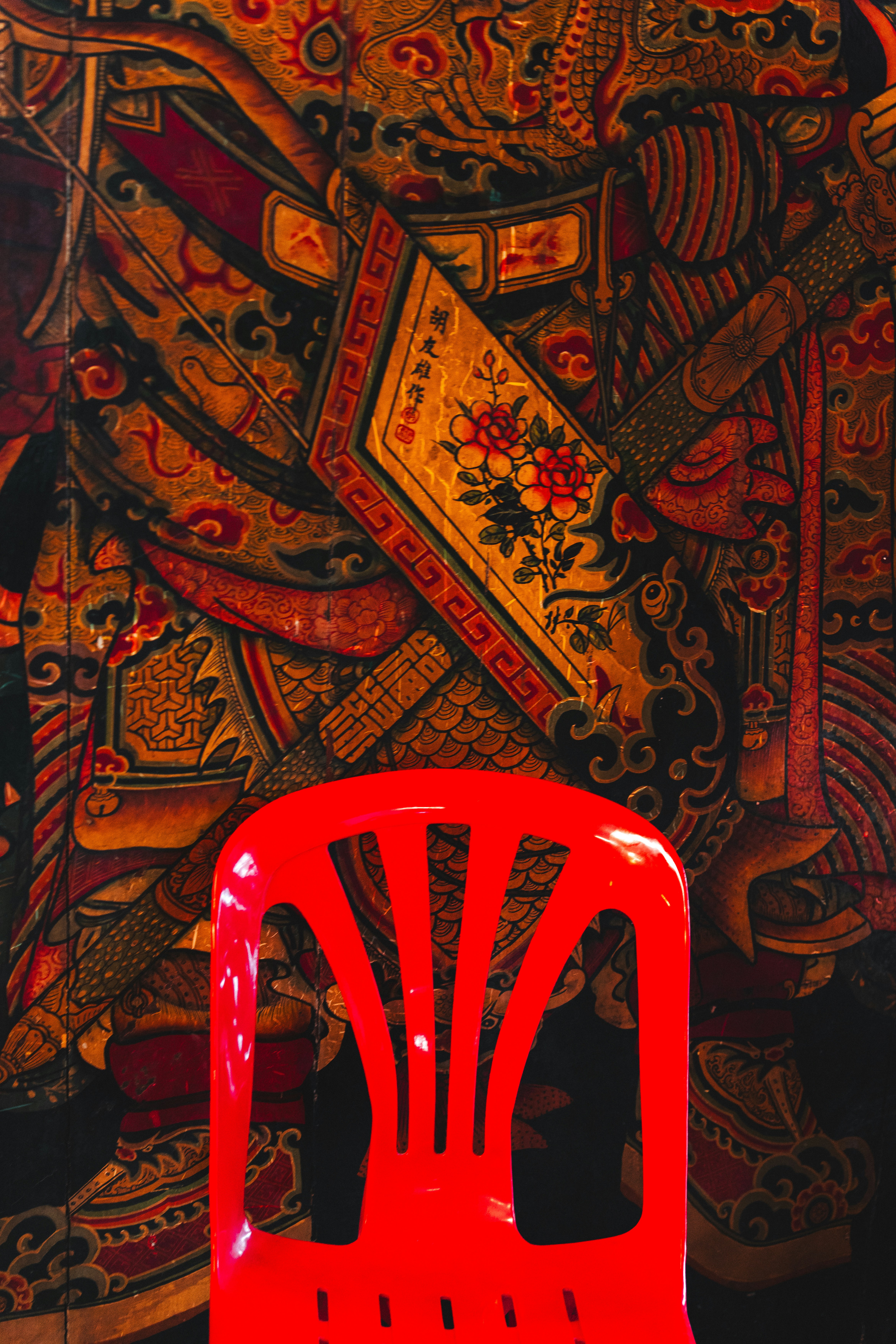 Red Chair in Front of Ornate Dragon-Trompe-Loeil Tapestry