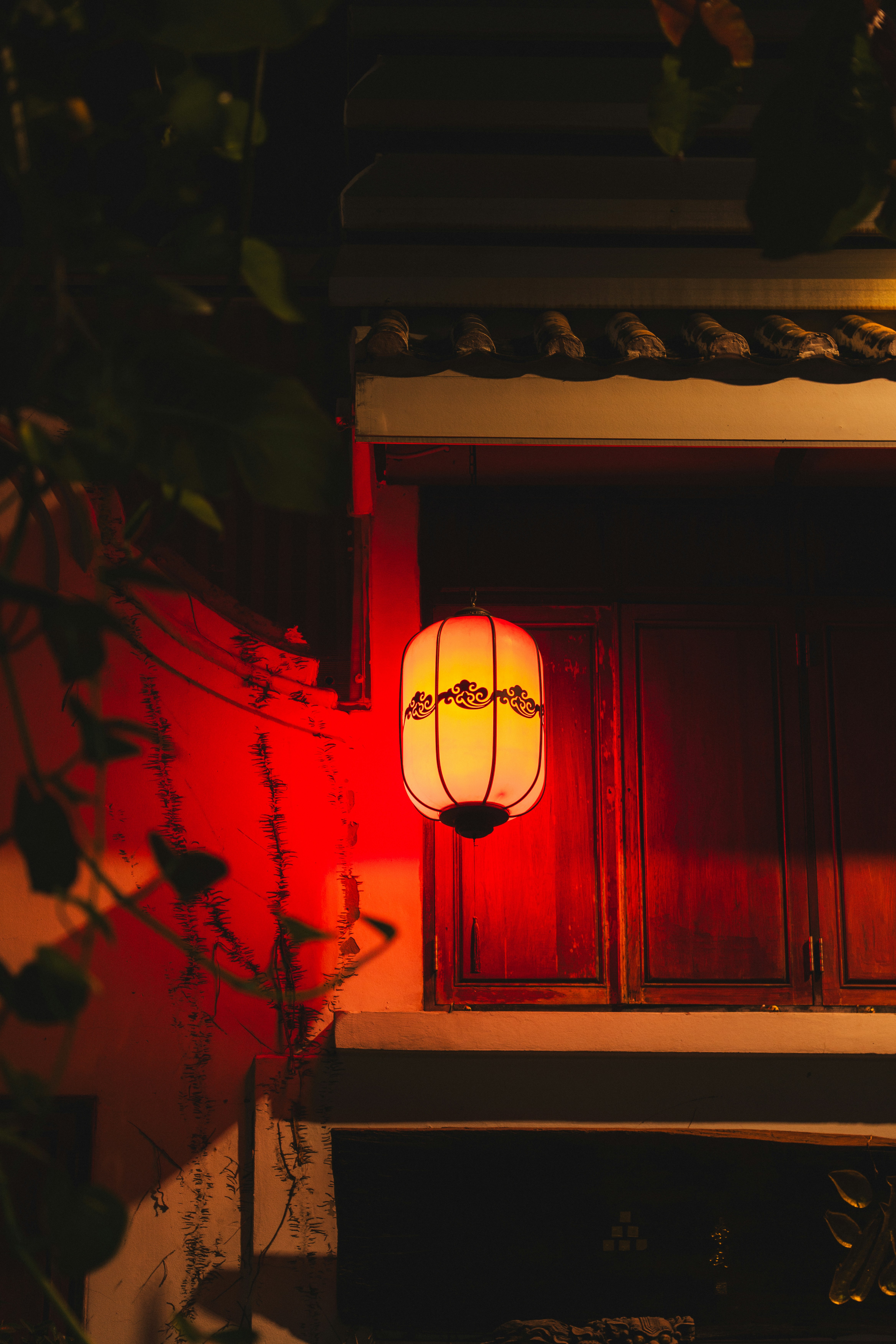 Red Lantern Quietness: A Garden Door Glows at Dusk