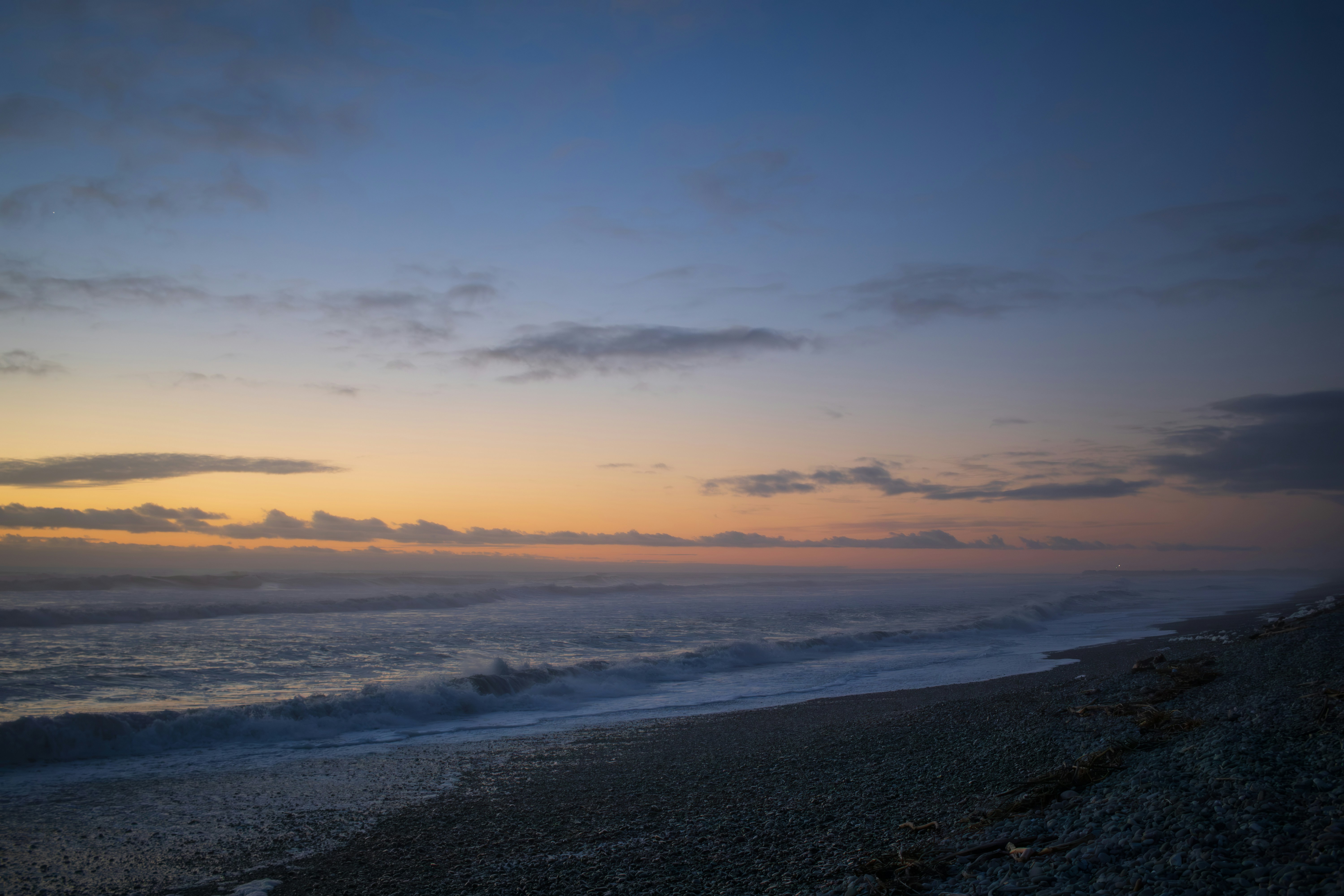 Dusk on the Pebble Beach: Quiet Horizon over Tidal Flats