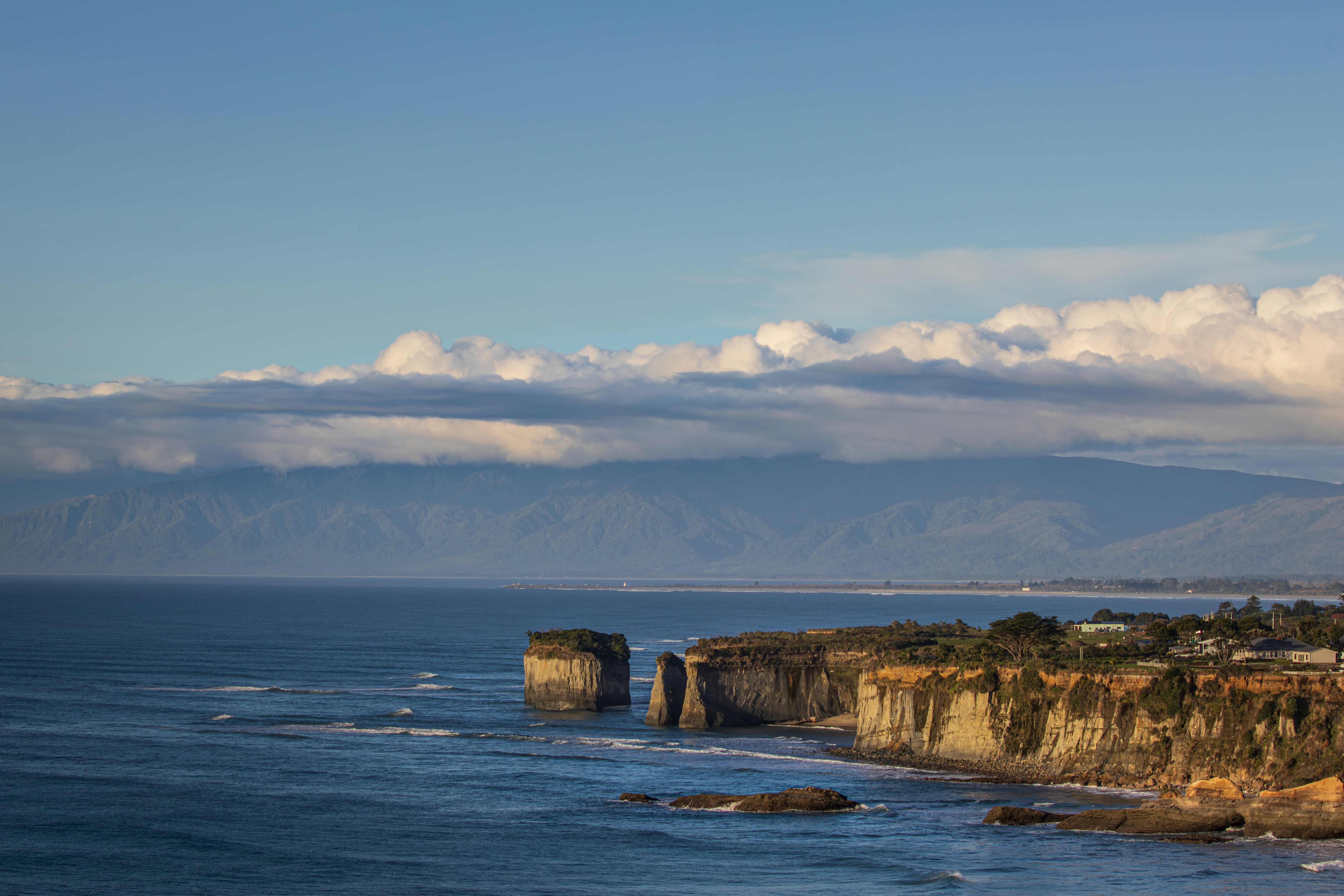 Cliffside Horizon: Coastal Light Over Azure Sea