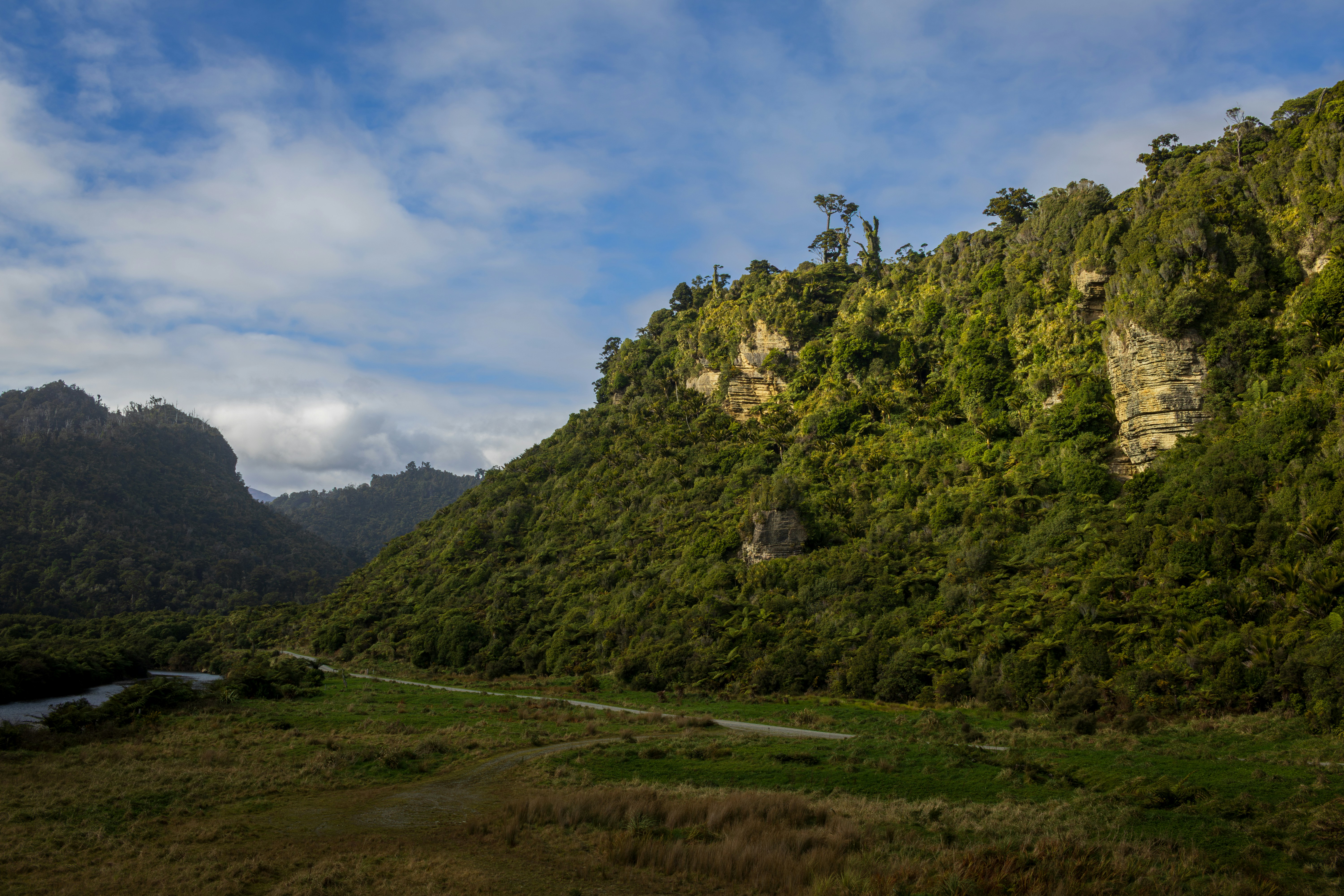 Sunlit Cliff Face over a Serene Gorge