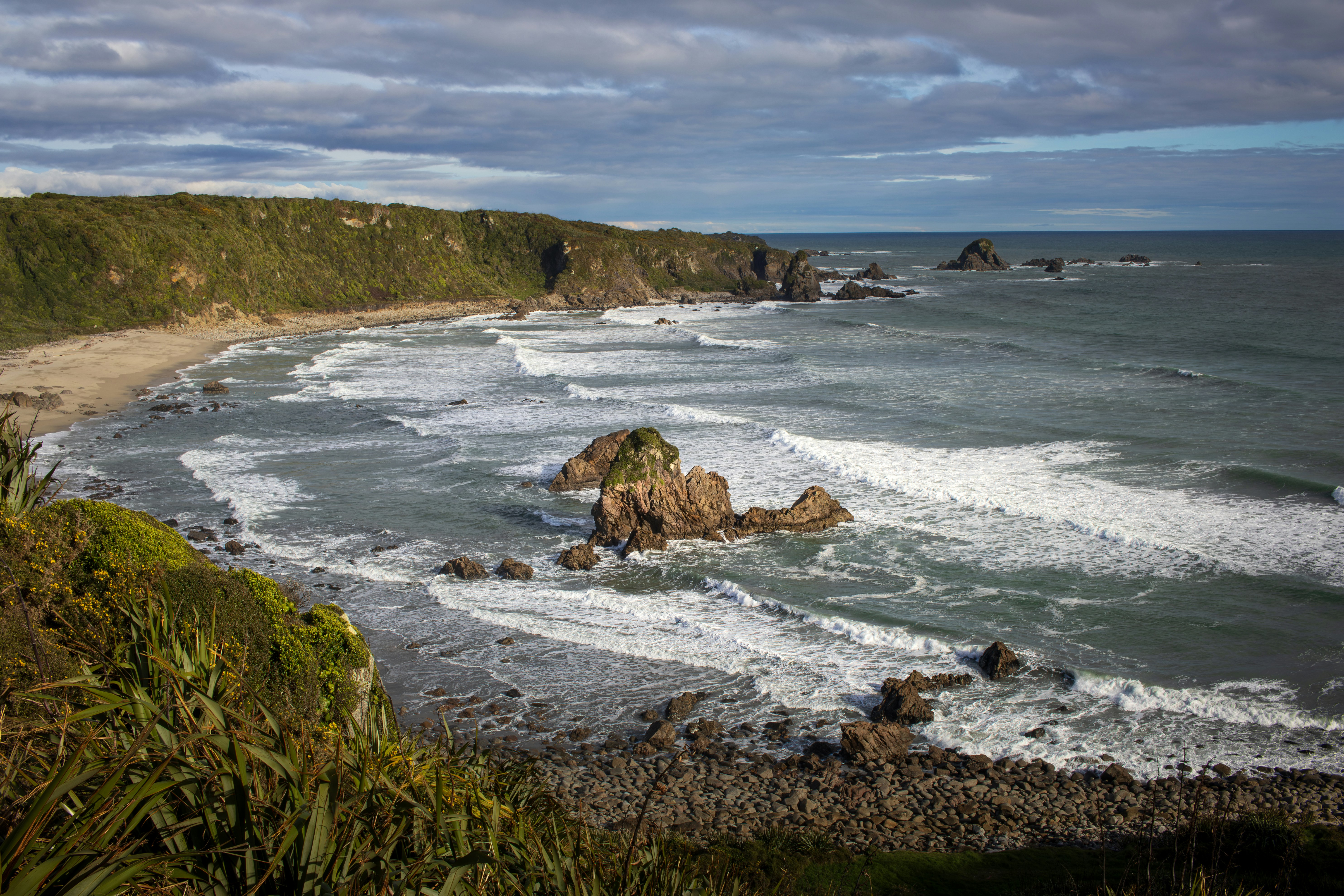 Cliffside Coastline – Greenery, Rocks and Rolling Tide