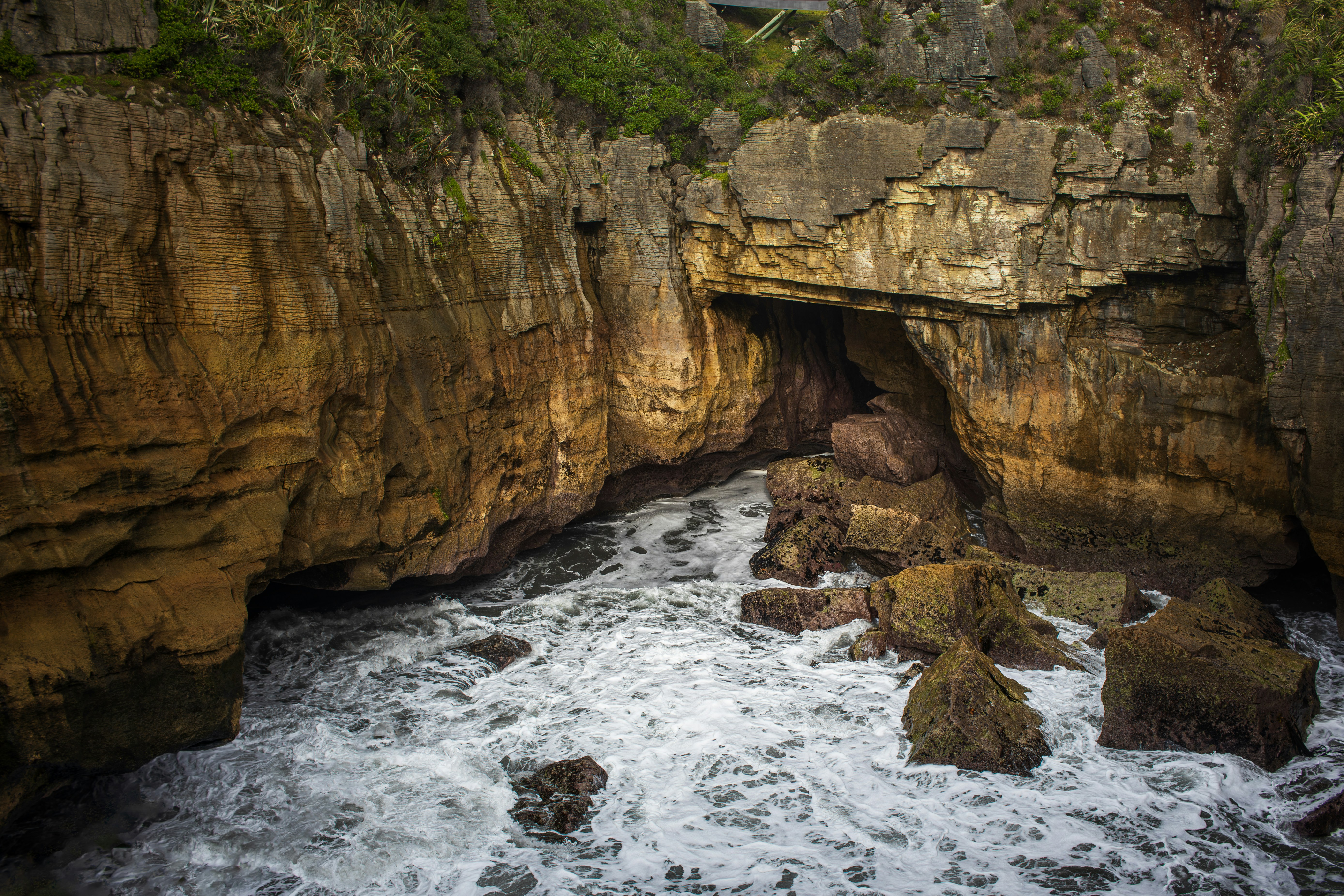 Sea Gate Under Rock: Waves Spill from a Cliff Cleft