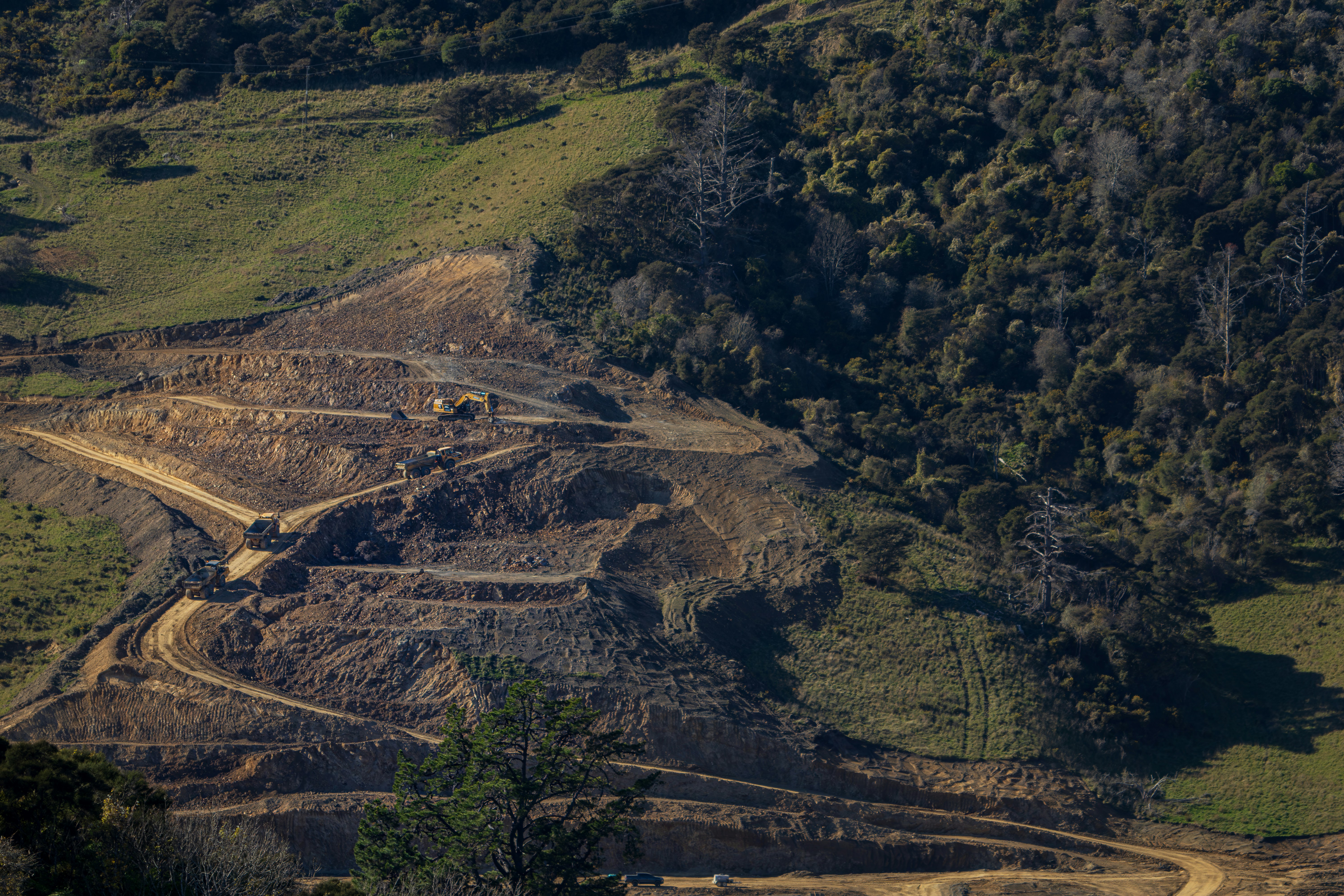 Terraced quarry weaving through sunlit hillside