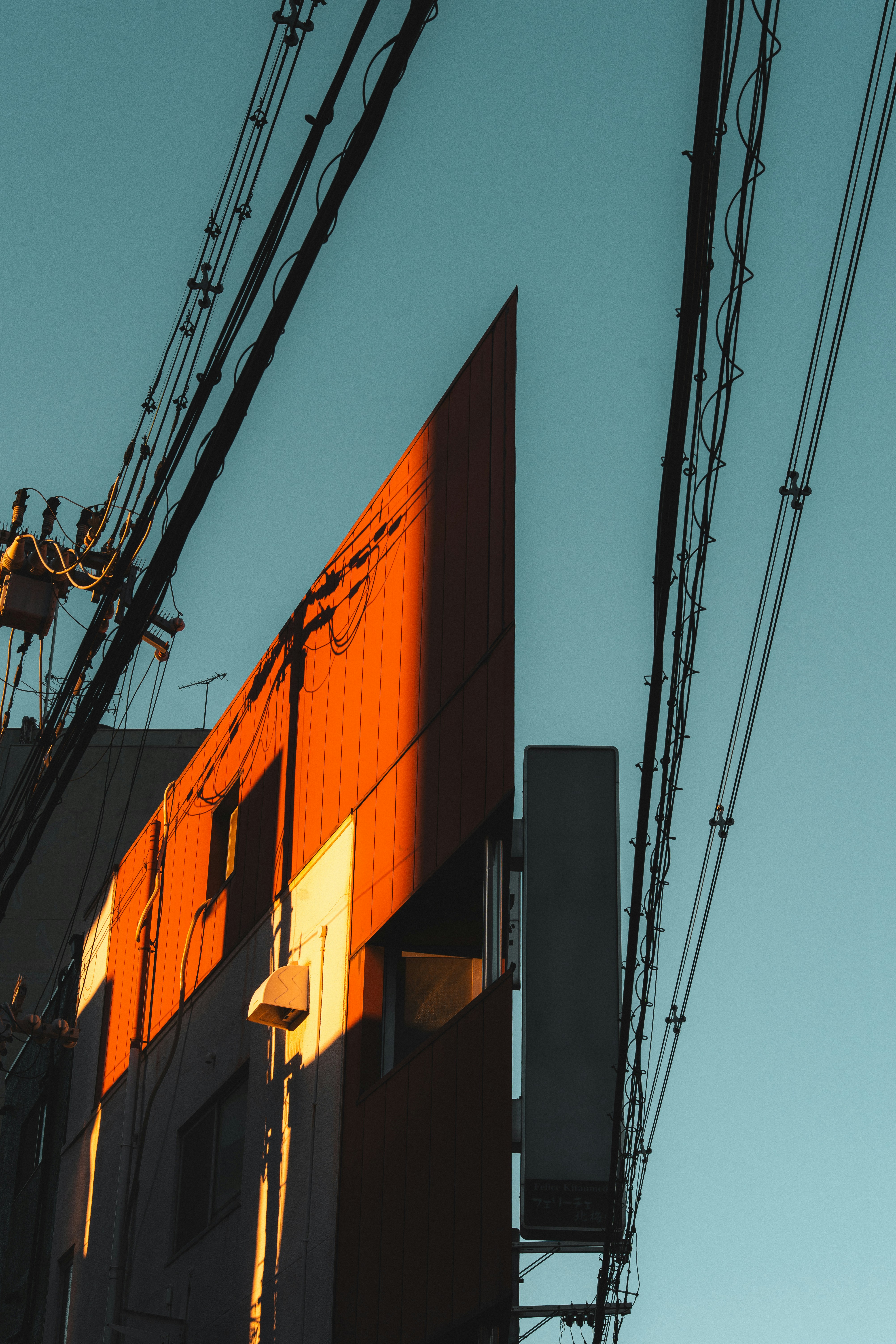 Orange Facade Burning Bright Against a Quiet Sky