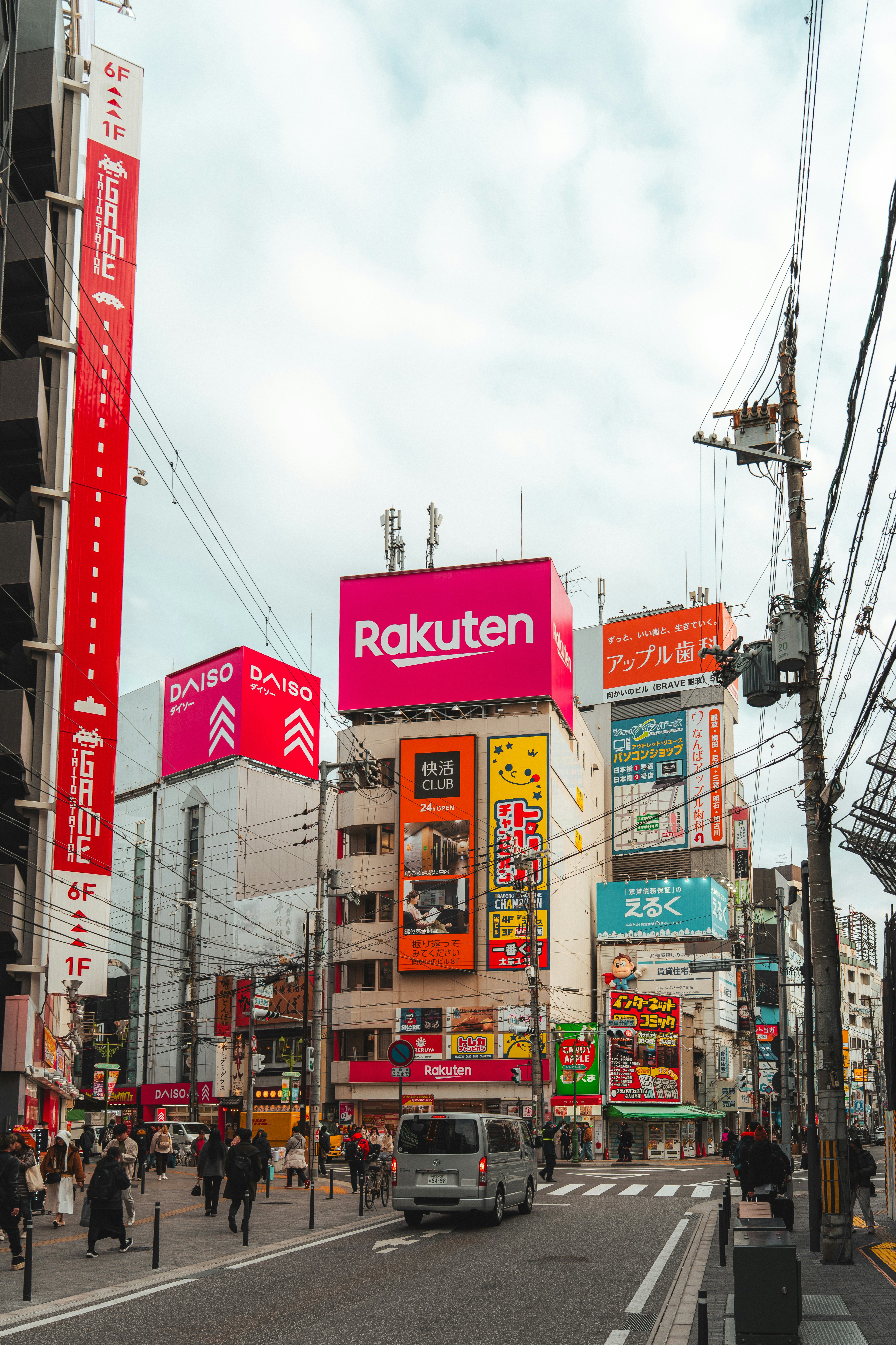 Vibrant Shoppers on a Busy Tokyo Street Under Bright Billboards