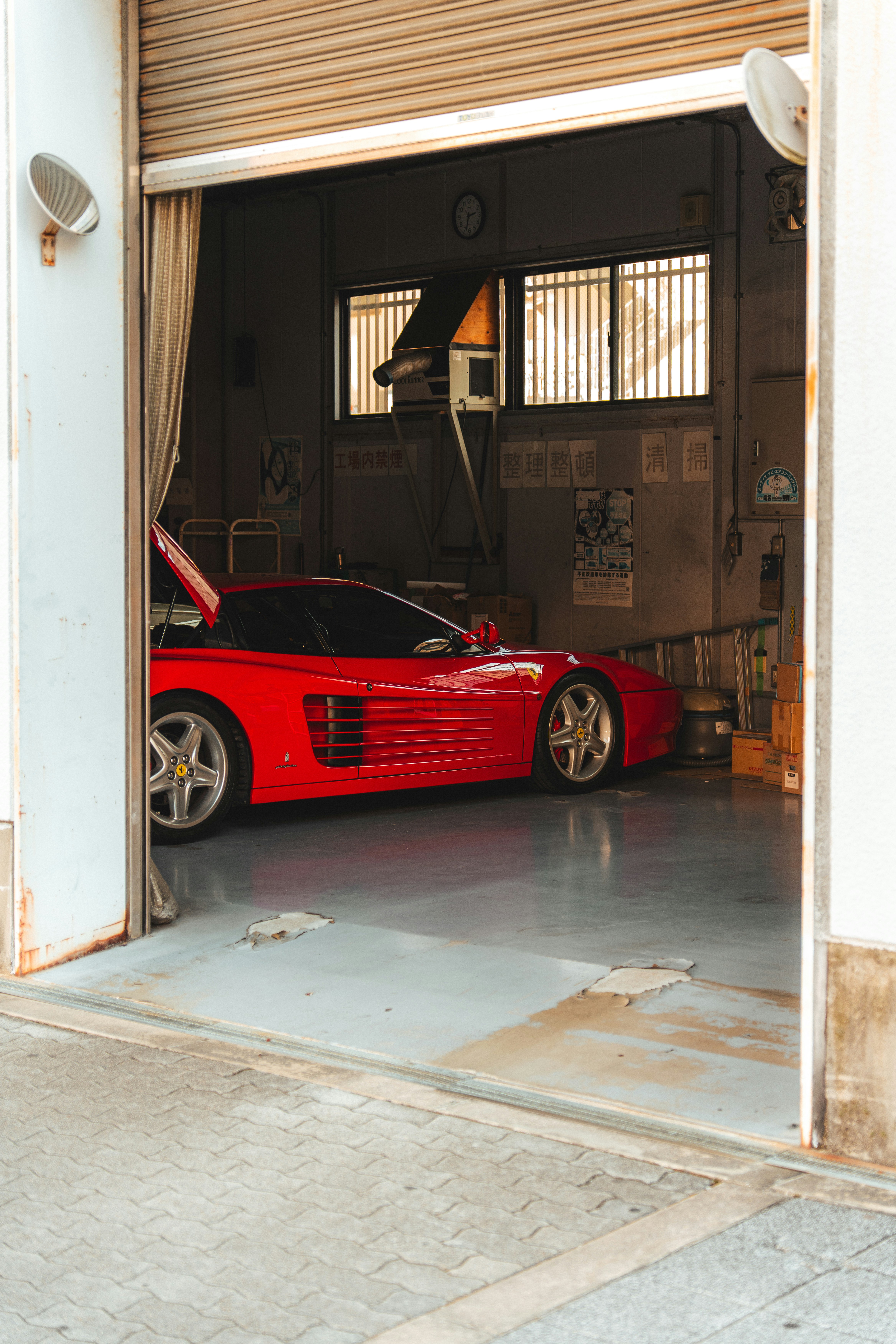 Red Ferrari in a Quiet Garage Wake of Light