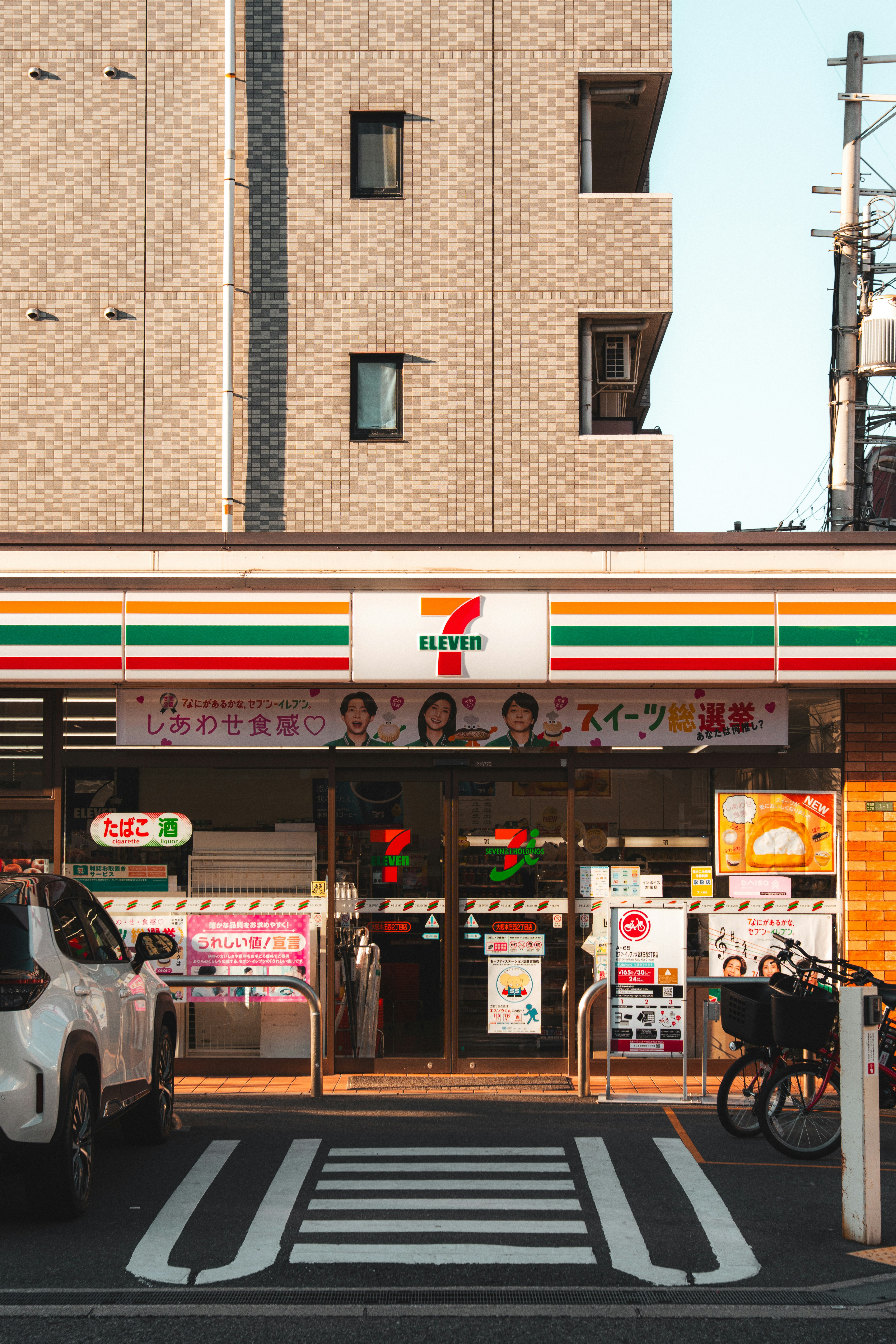 Ground-floor Convenience: A 7-Eleven Beneath an Urban Brick Facade