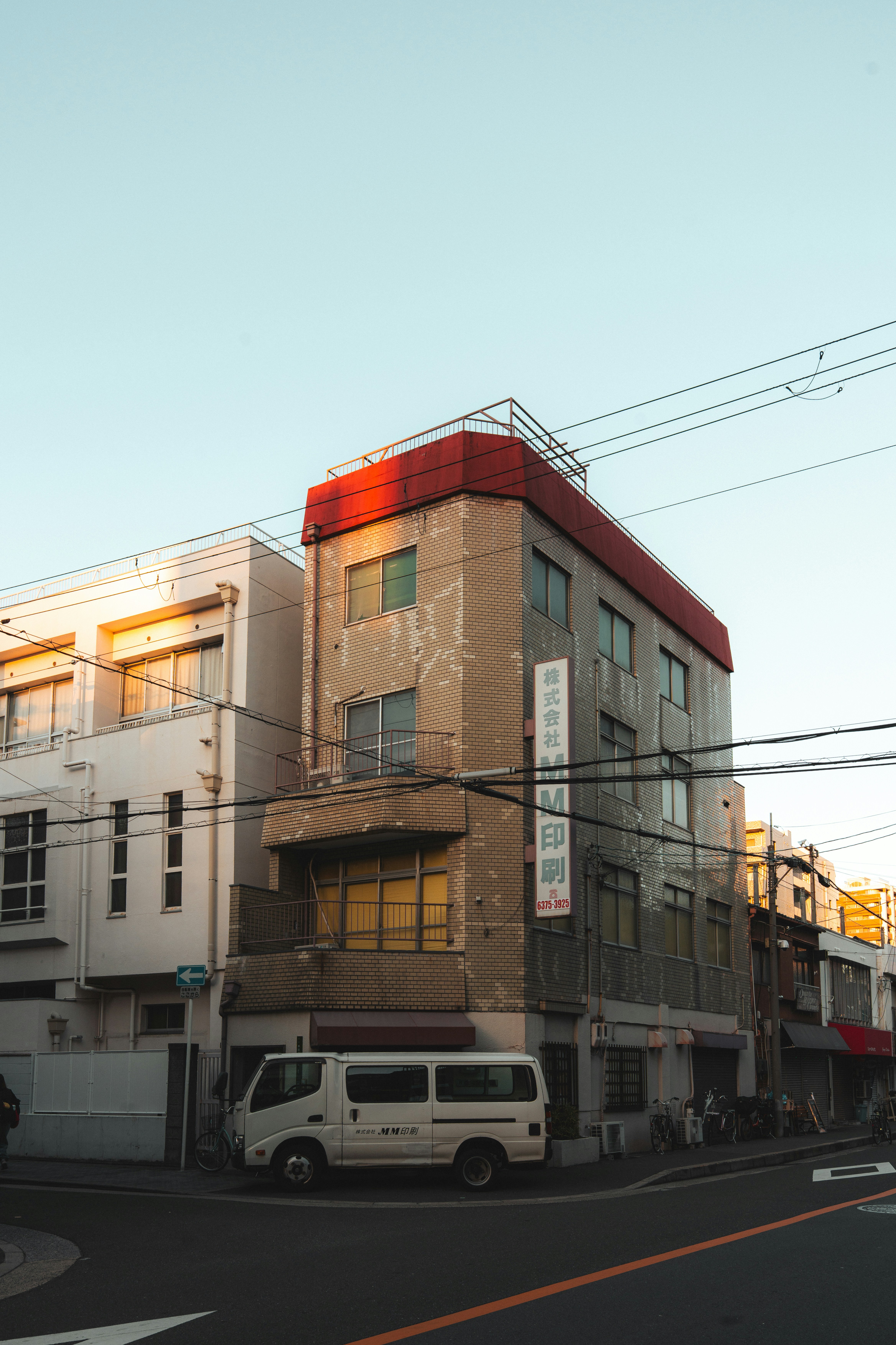 Cornered in the City: A Quiet Street Corner with a Red-roofed Building