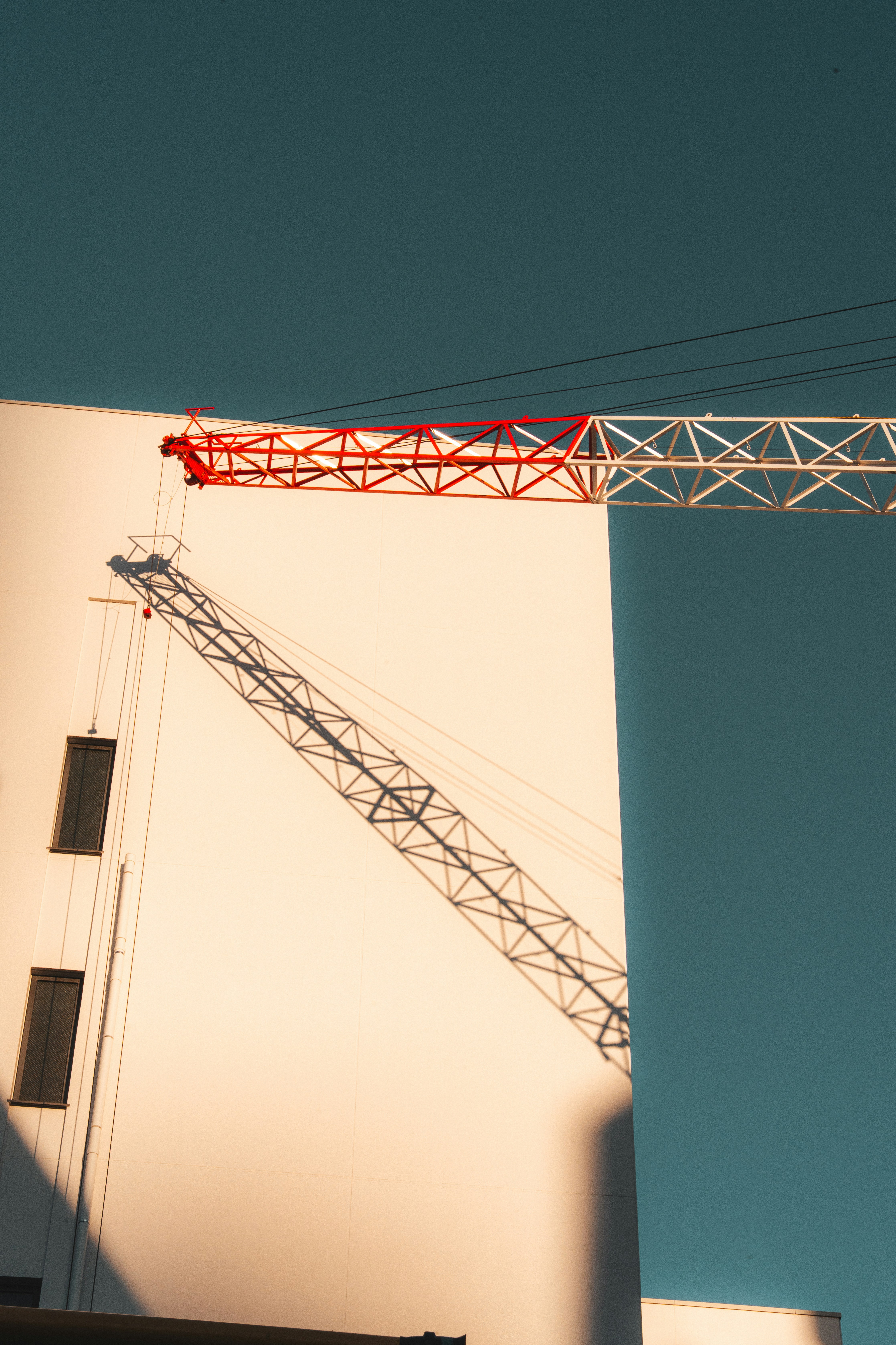 Crane Geometry Against Modern Facade