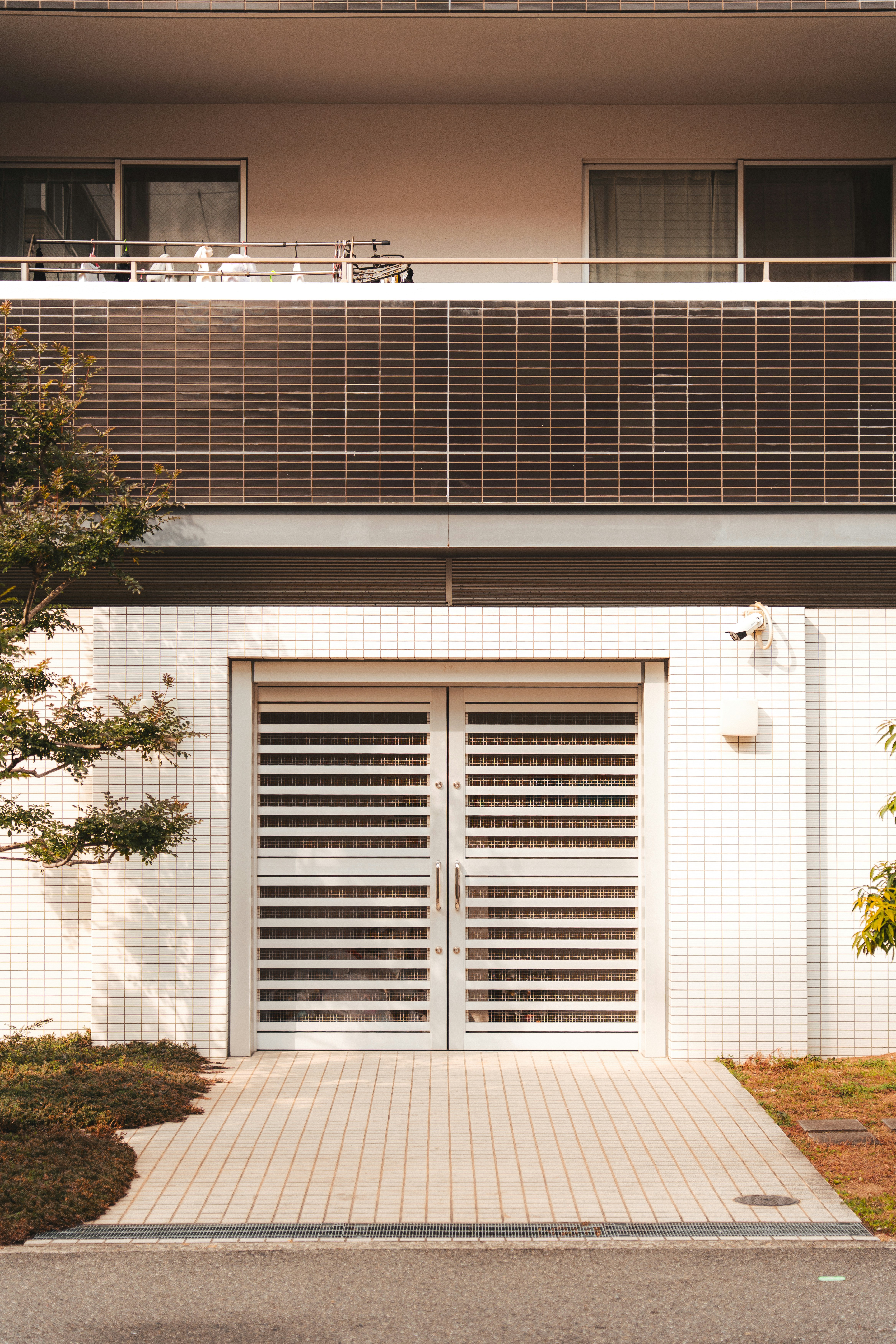 Industrial Calm: A Frontal View of a Modern Gate Between Urban Facades