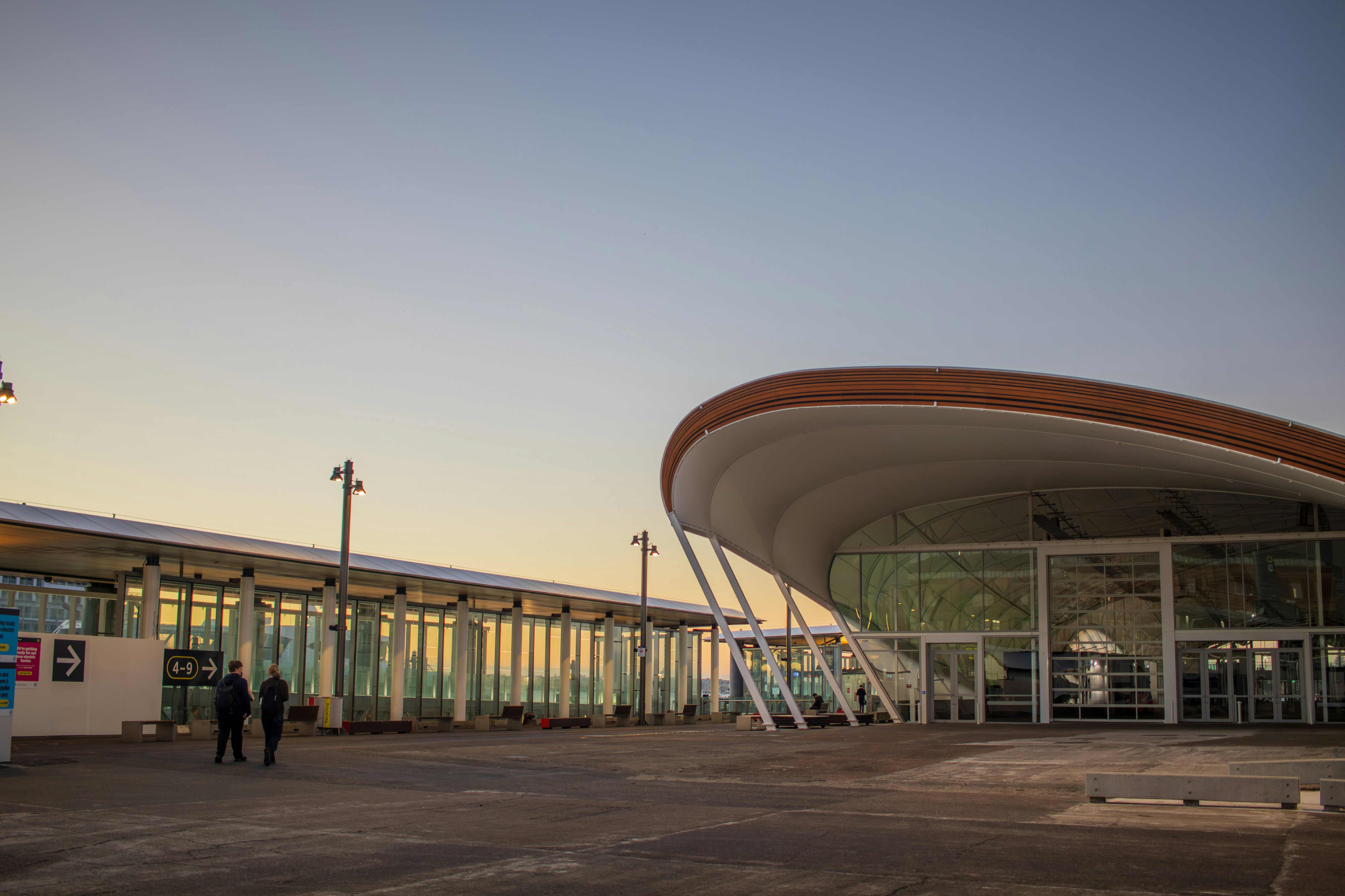 Architects of Tomorrow: The Curved Canopy Among Glass and Dusk