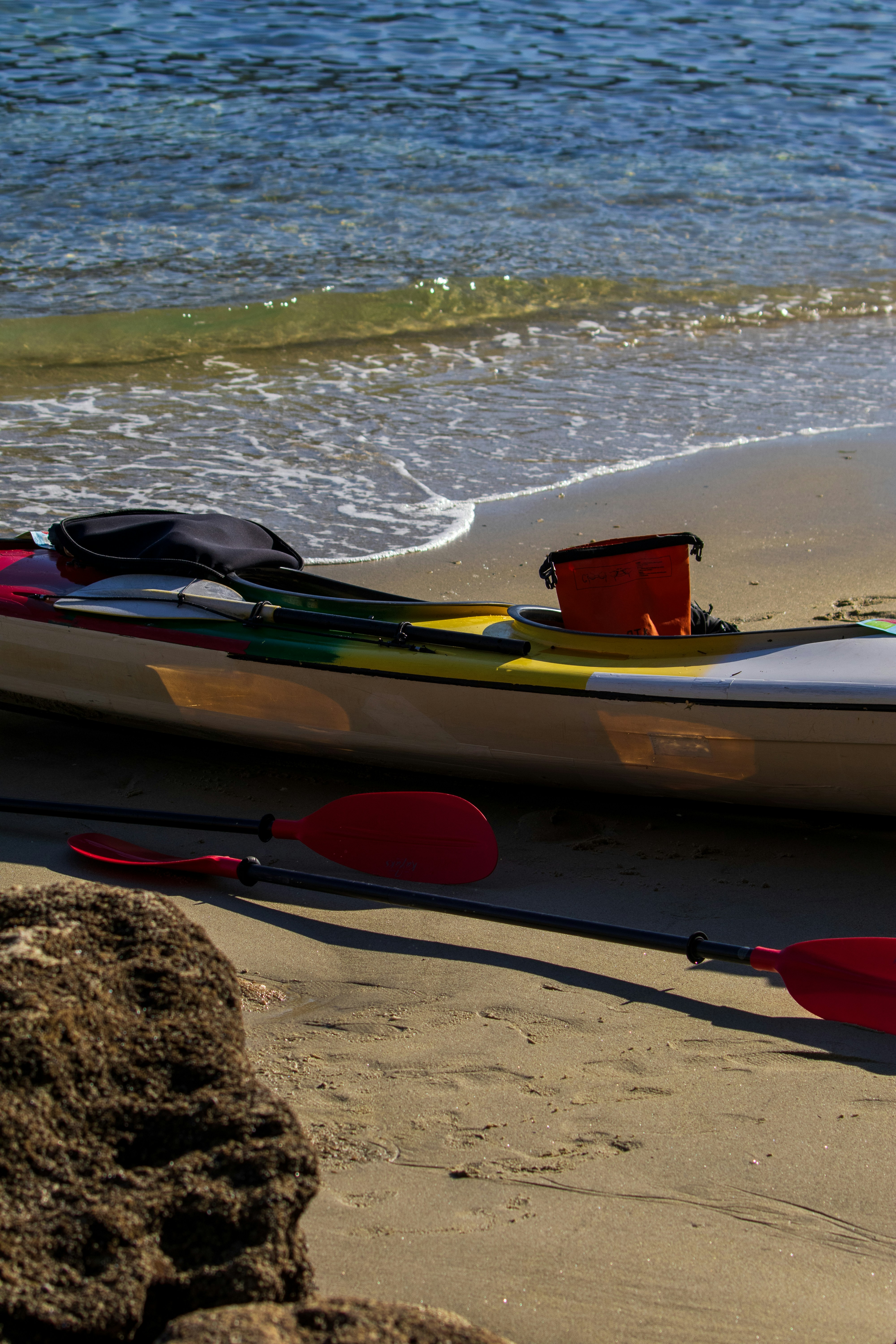 Colorful Kayak Row on Quiet Shoreline