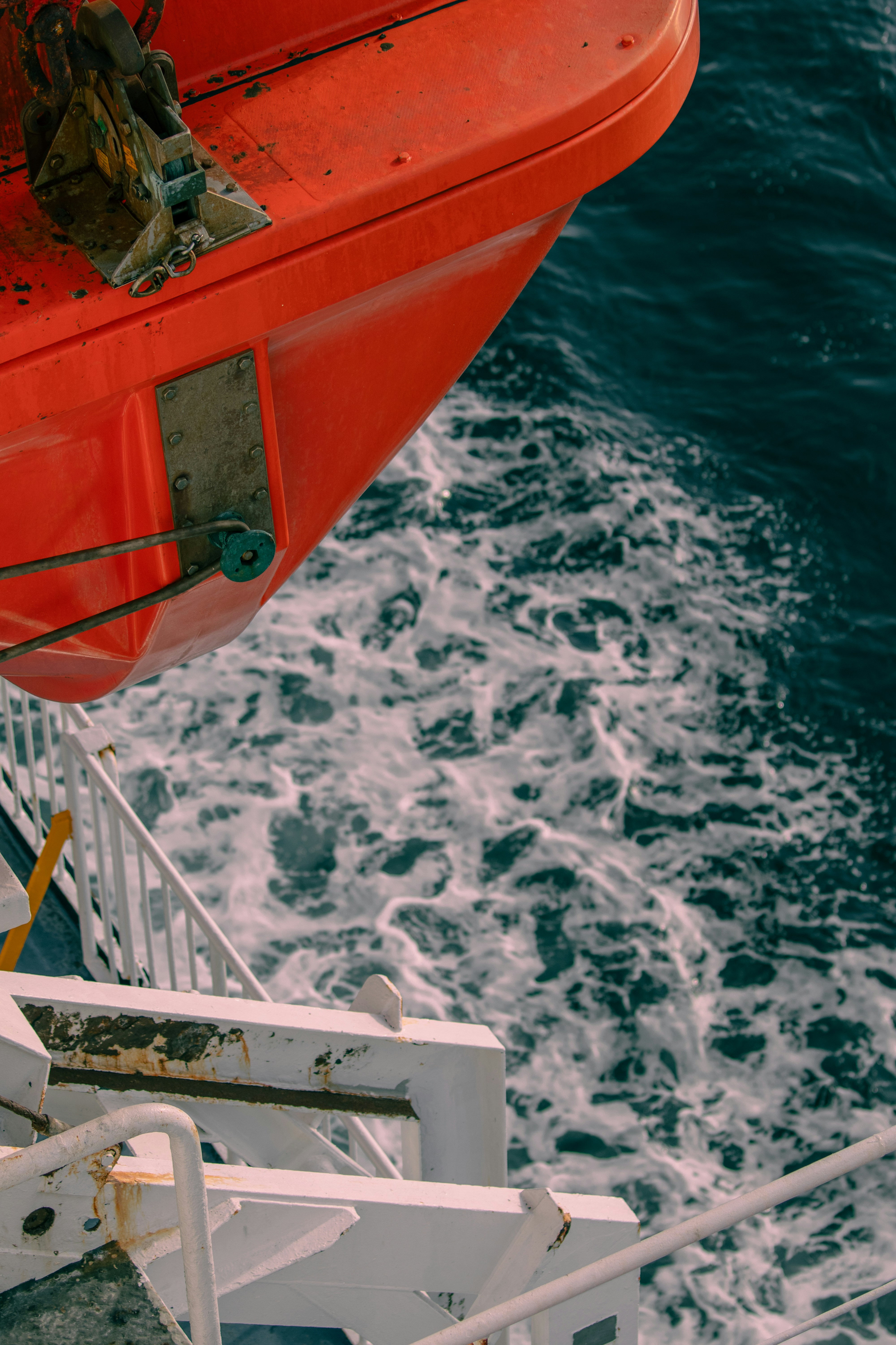 Red Fulcrum Over Sea: The Lifeboat Crest at Dusk