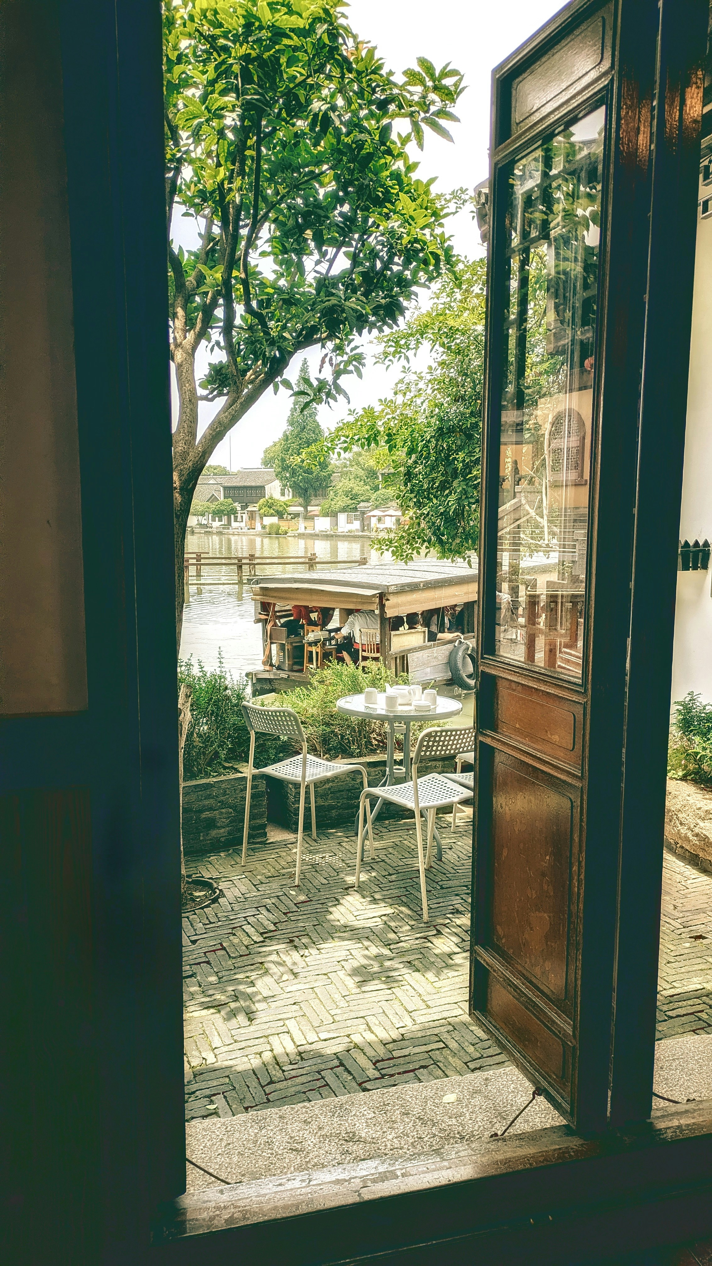 Doorway to a Quiet Courtyard Café by the Canal