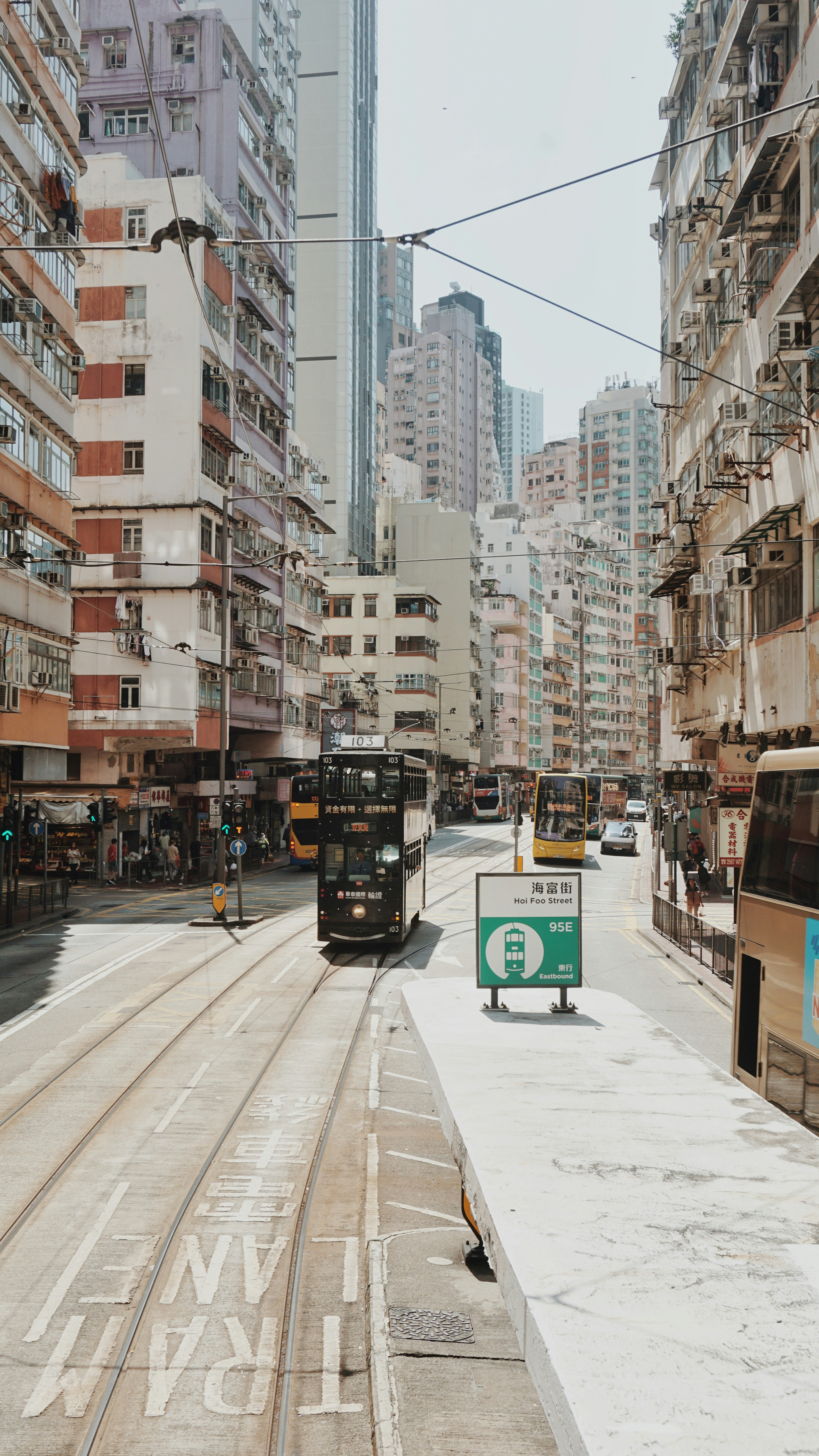 Urban Tram Lines Converging Under a World of High-Rrise Canopies