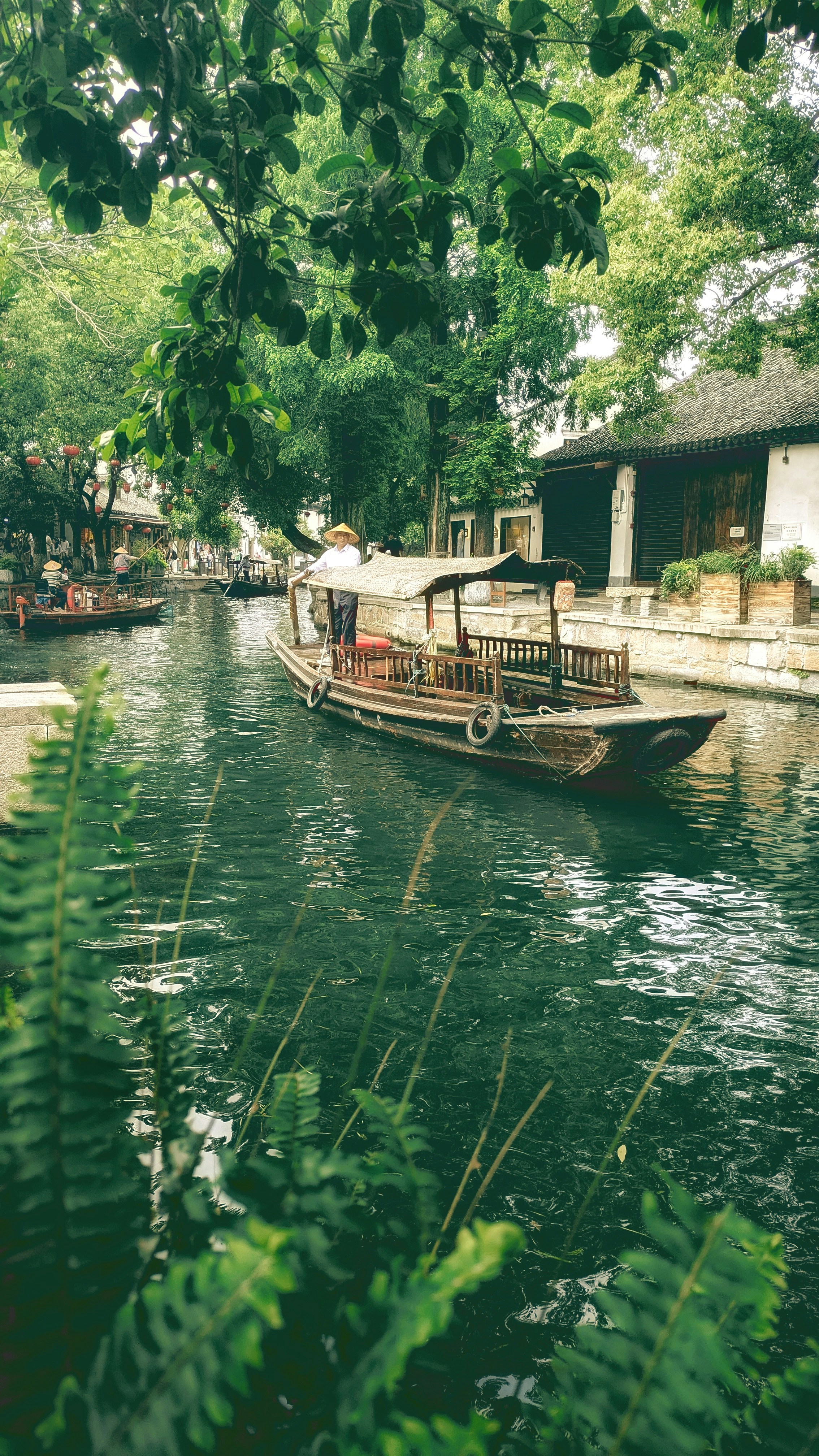 A Quiet Boat Drift Through a Verdant Canal