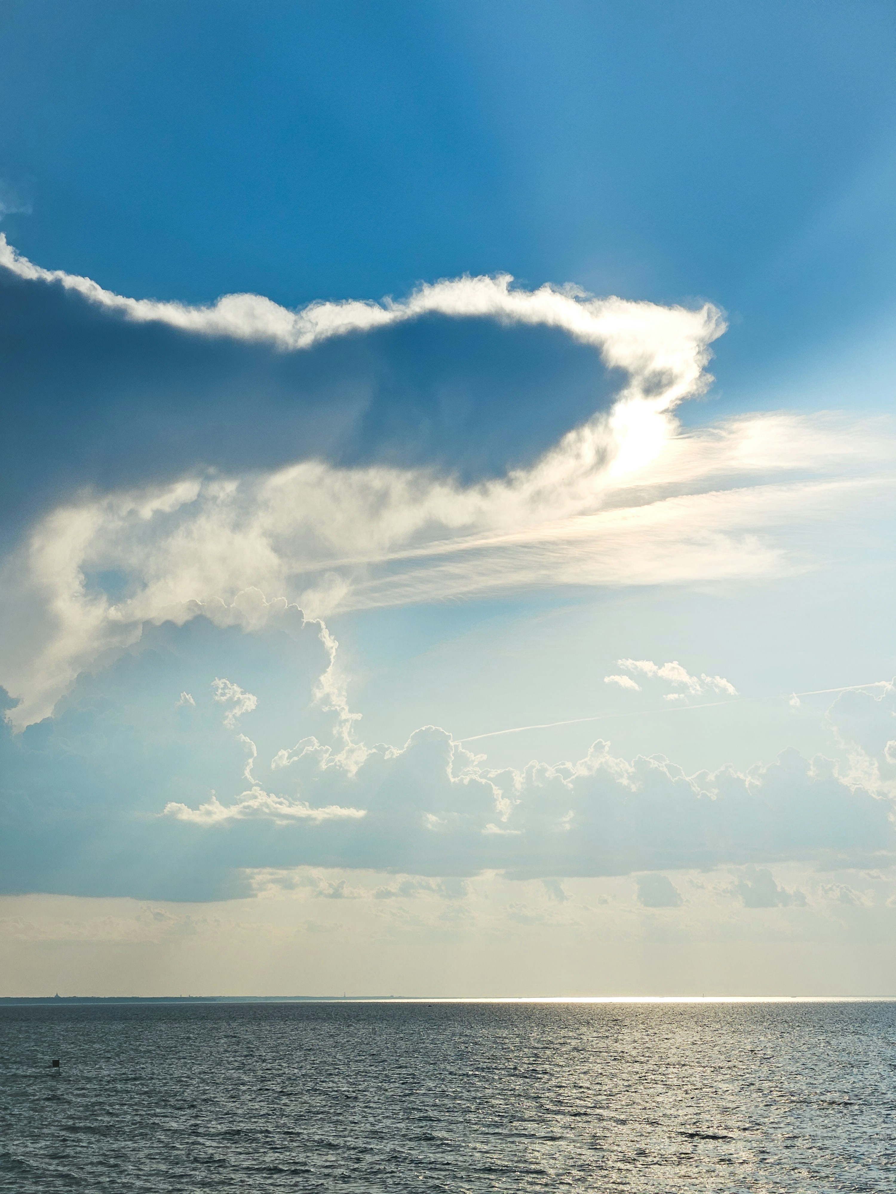 Edge of Light: Cloud Curtain Over a Quiet Horizon