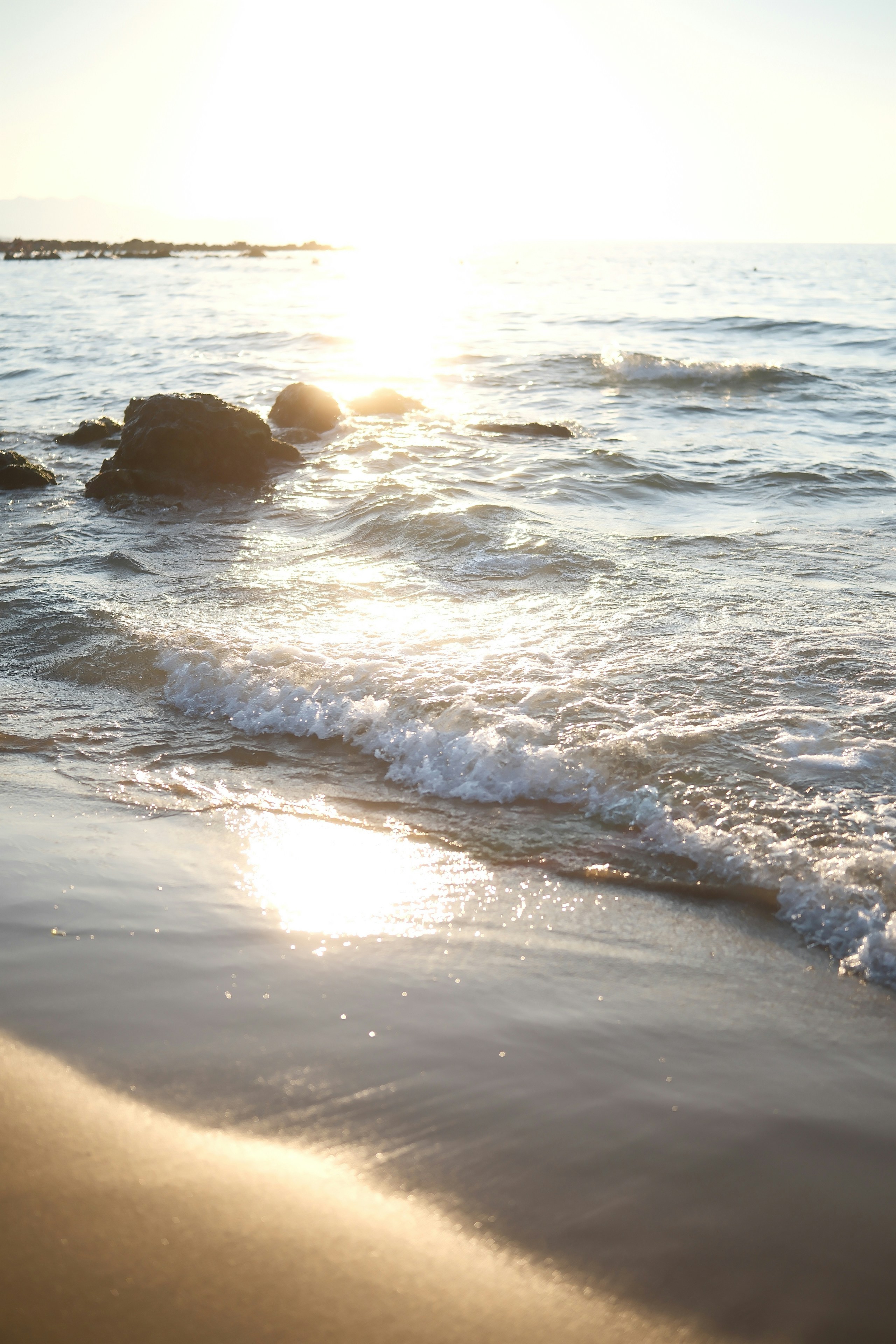 Sunlit Shoreline: Quiet Dance of Light on Waves