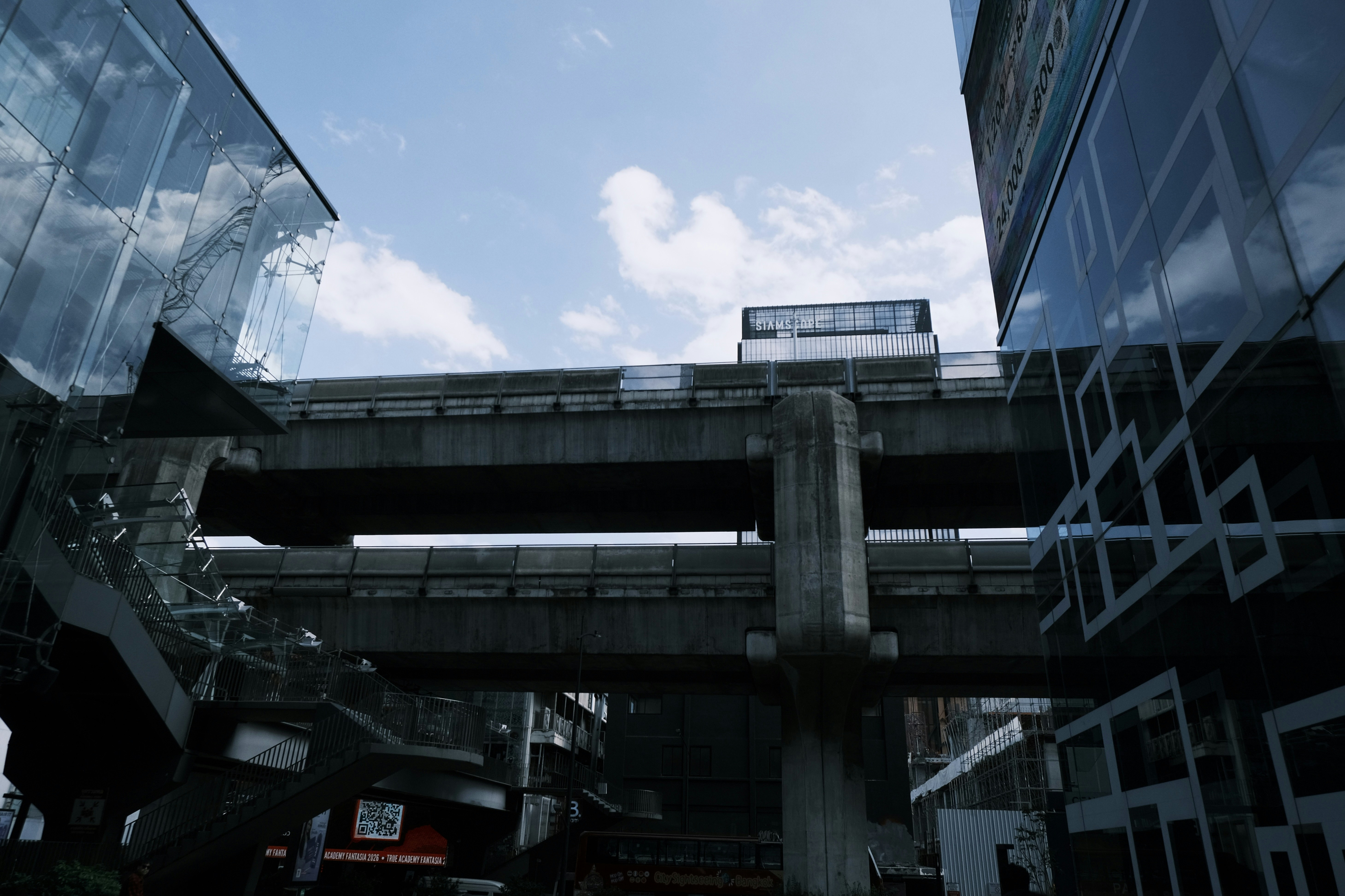 Industrial Sliver: Skyward Rails Between Glass and Concrete