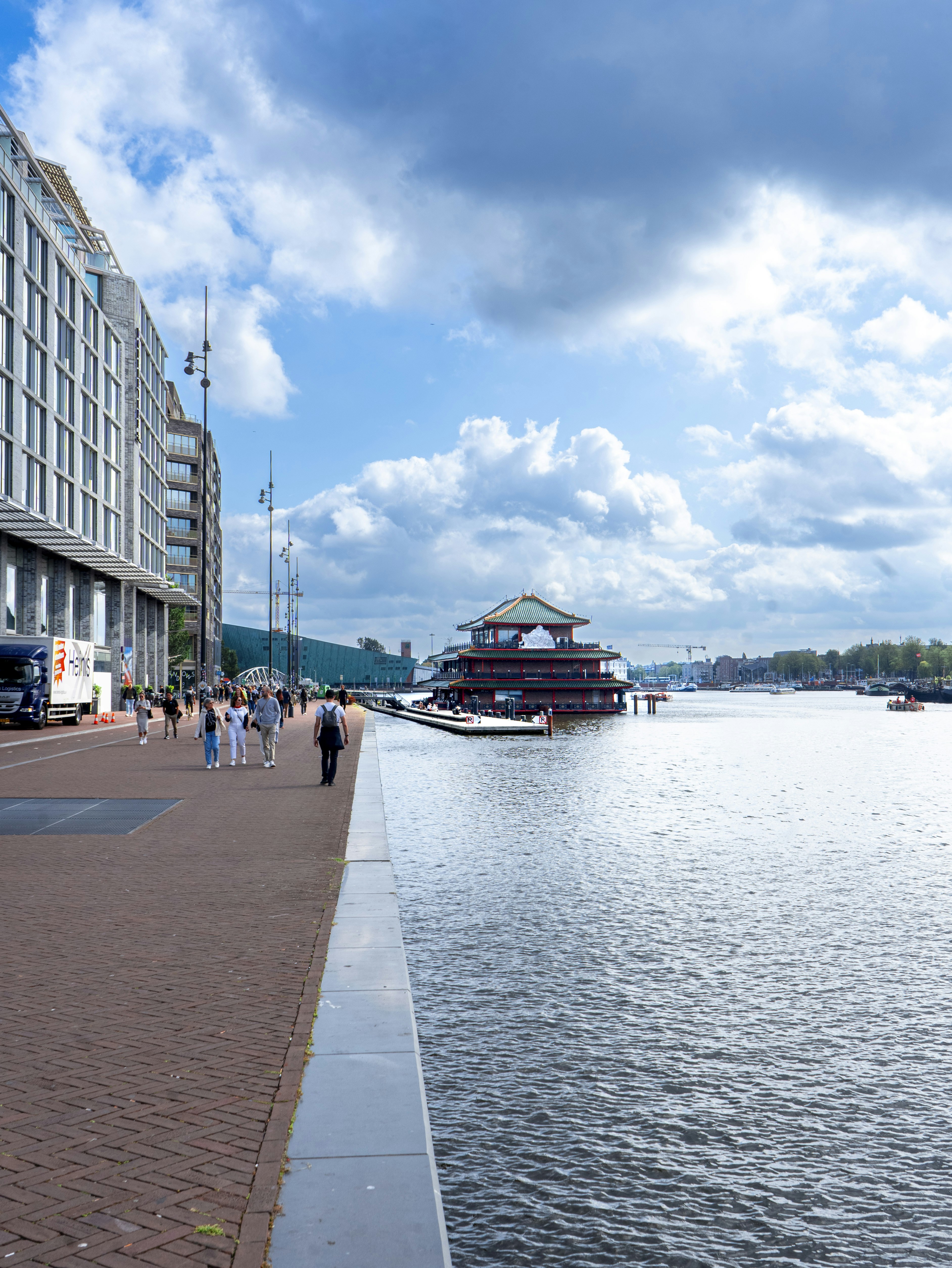 Harbor Walkway: A Modern Promenade with a Temple Boat in the Thames-like Waterfront