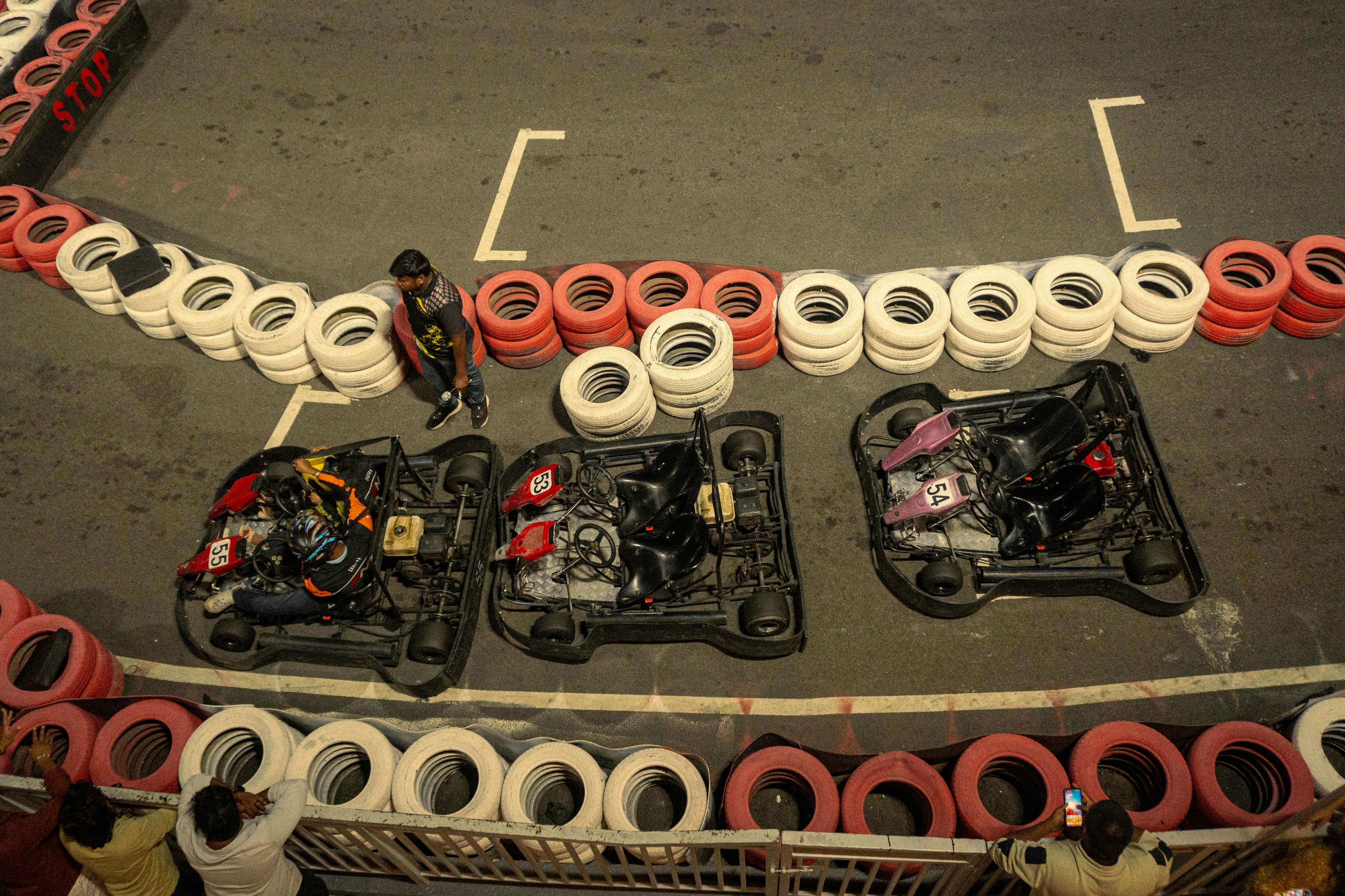 RC Car Speedway: Aerial Drift Amid Colorful Tire Barriers