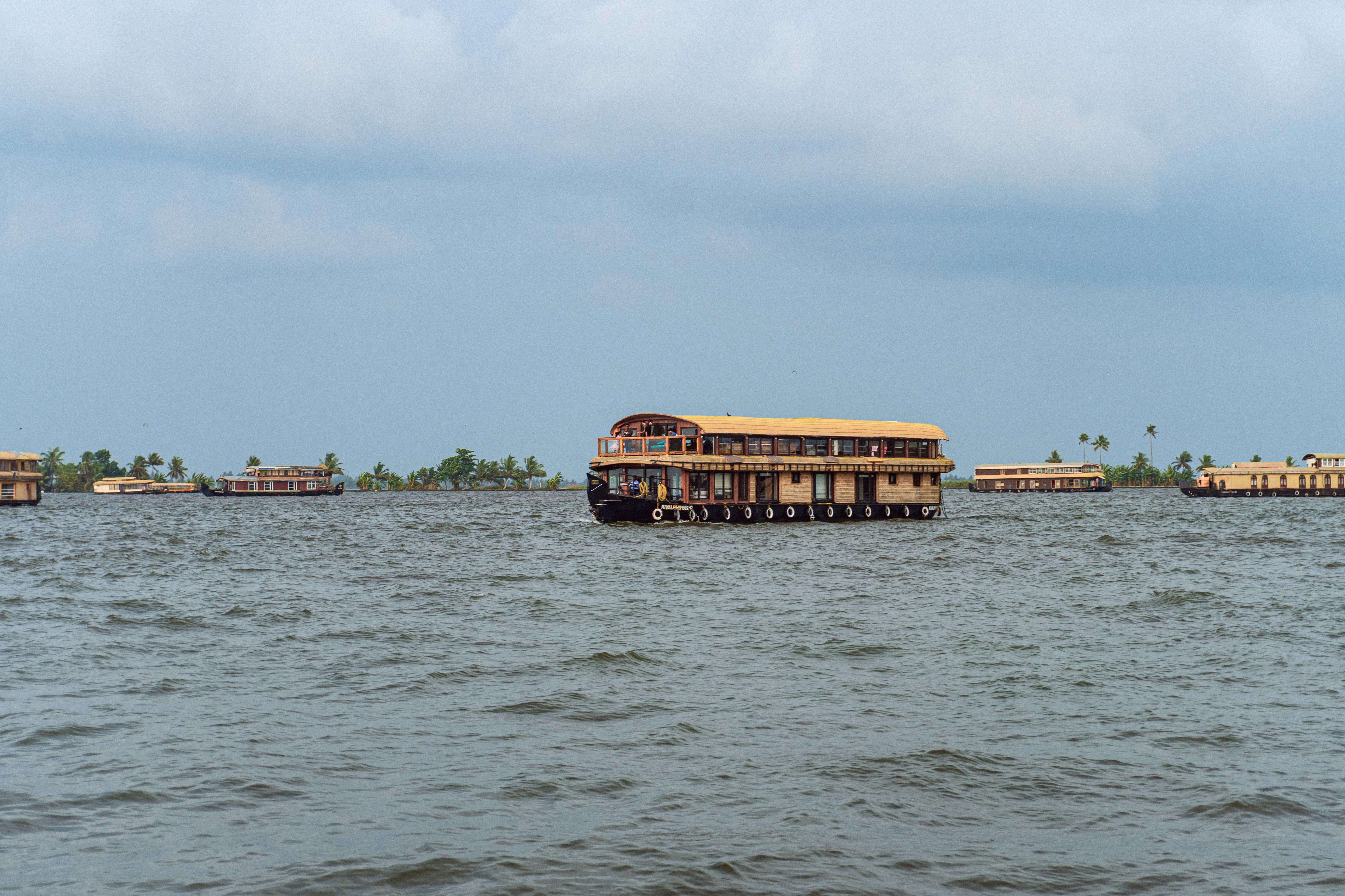 Floating Colony: A Row of Houseboats Adrift on Calm Waters