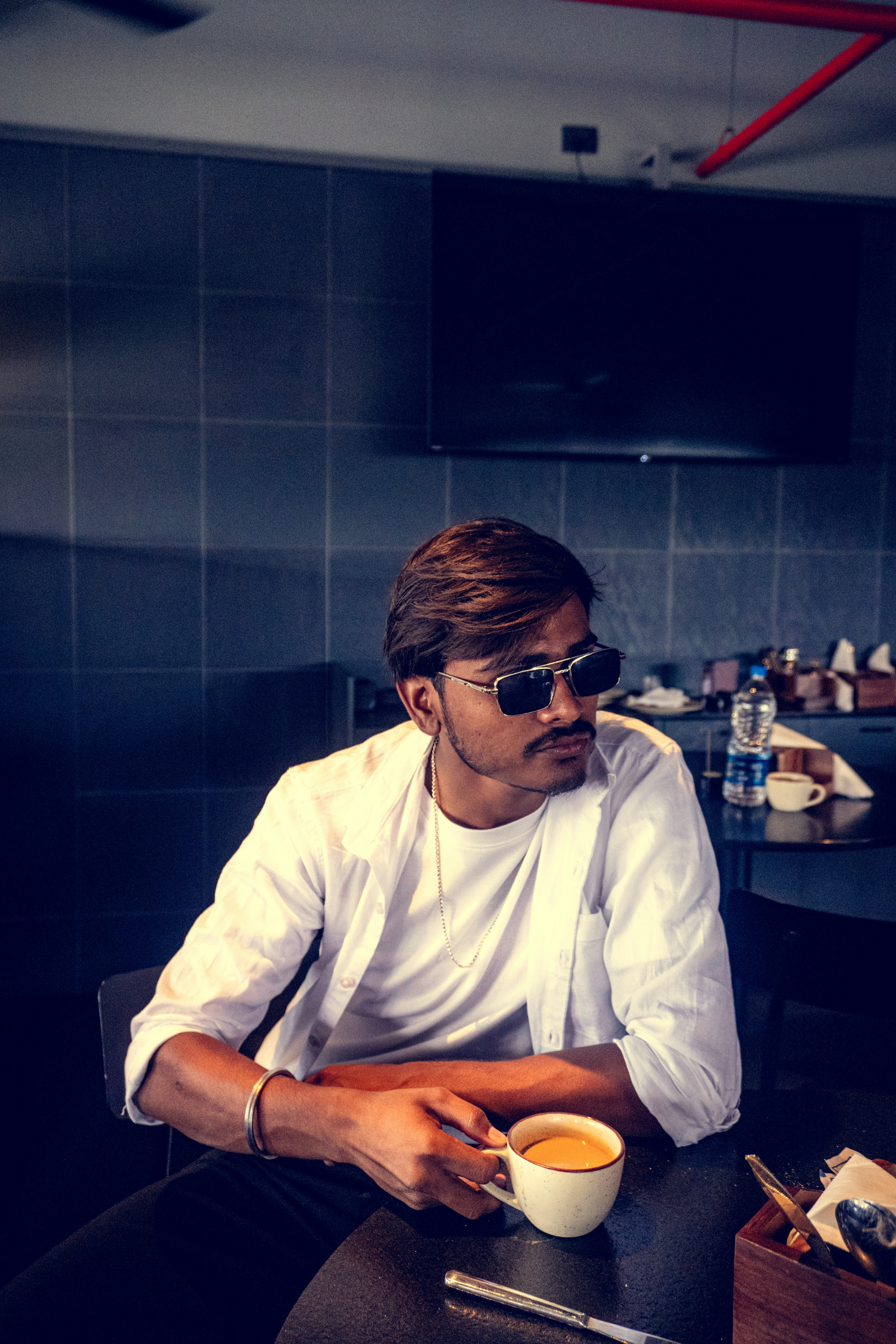 Crewed in White: A Quiet Moment Over Coffee