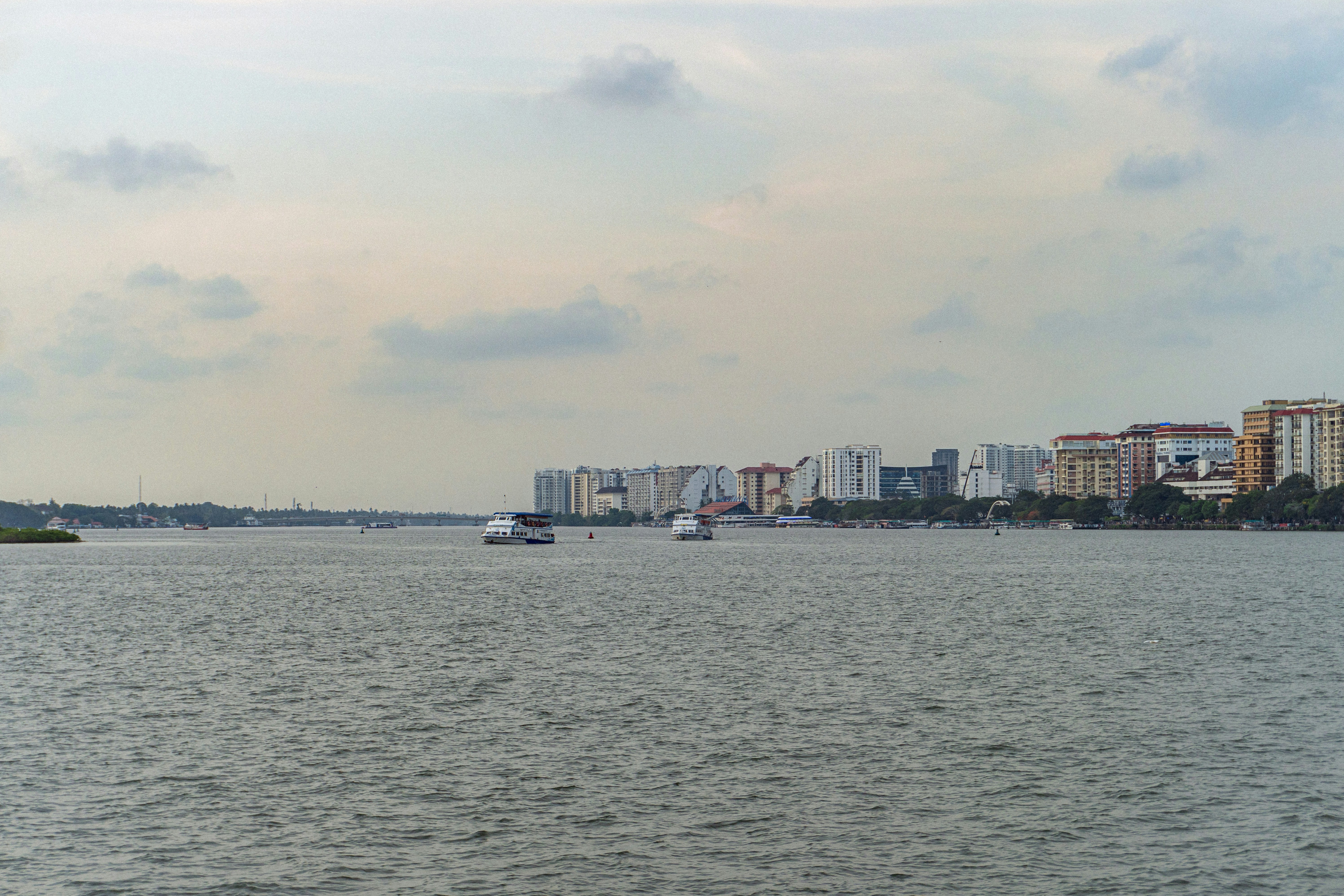 Harbor Glass: Boats and Cityscape Across Calm Waters