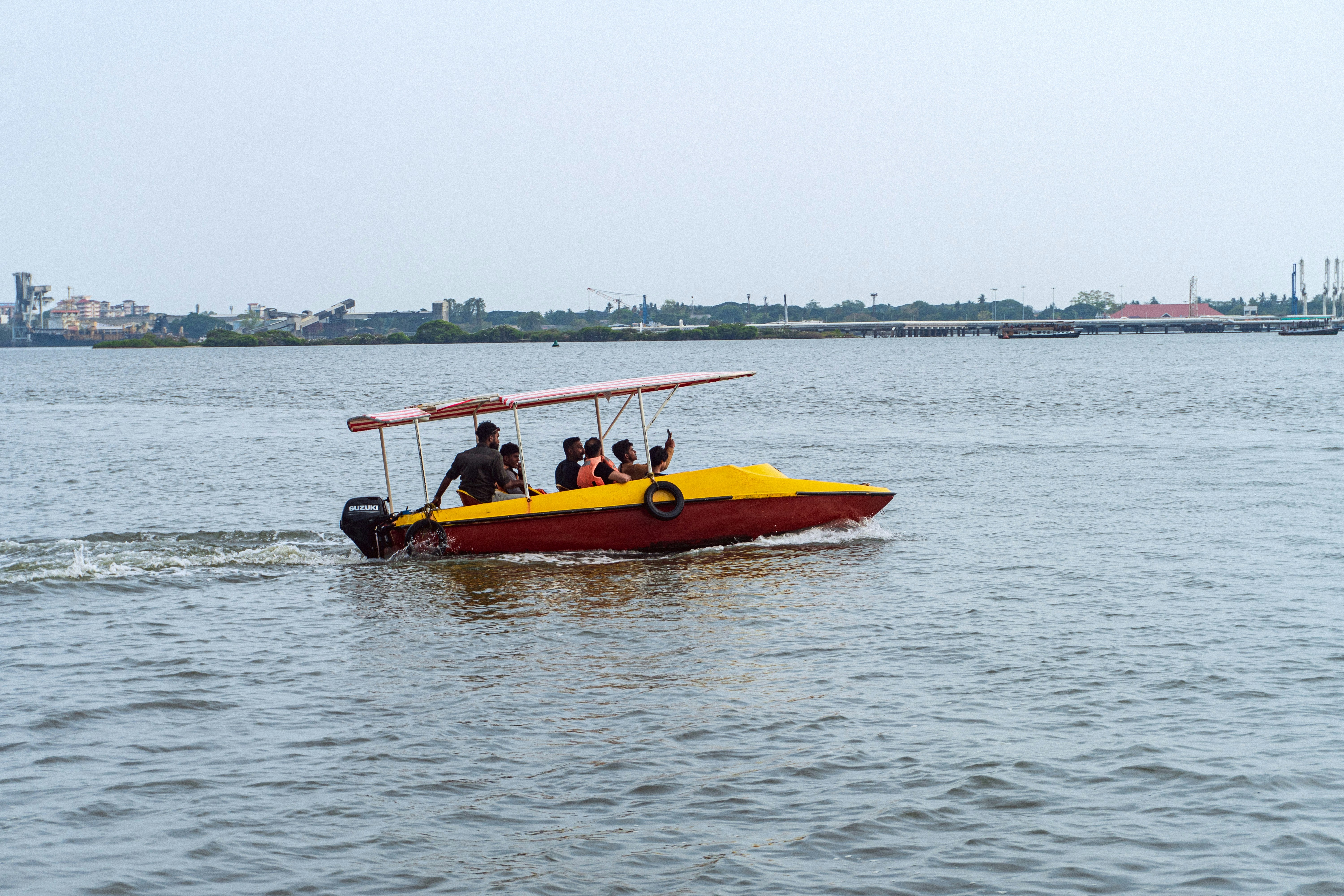 Yellow-Red Powerboat Cutting Through Calm Waters
