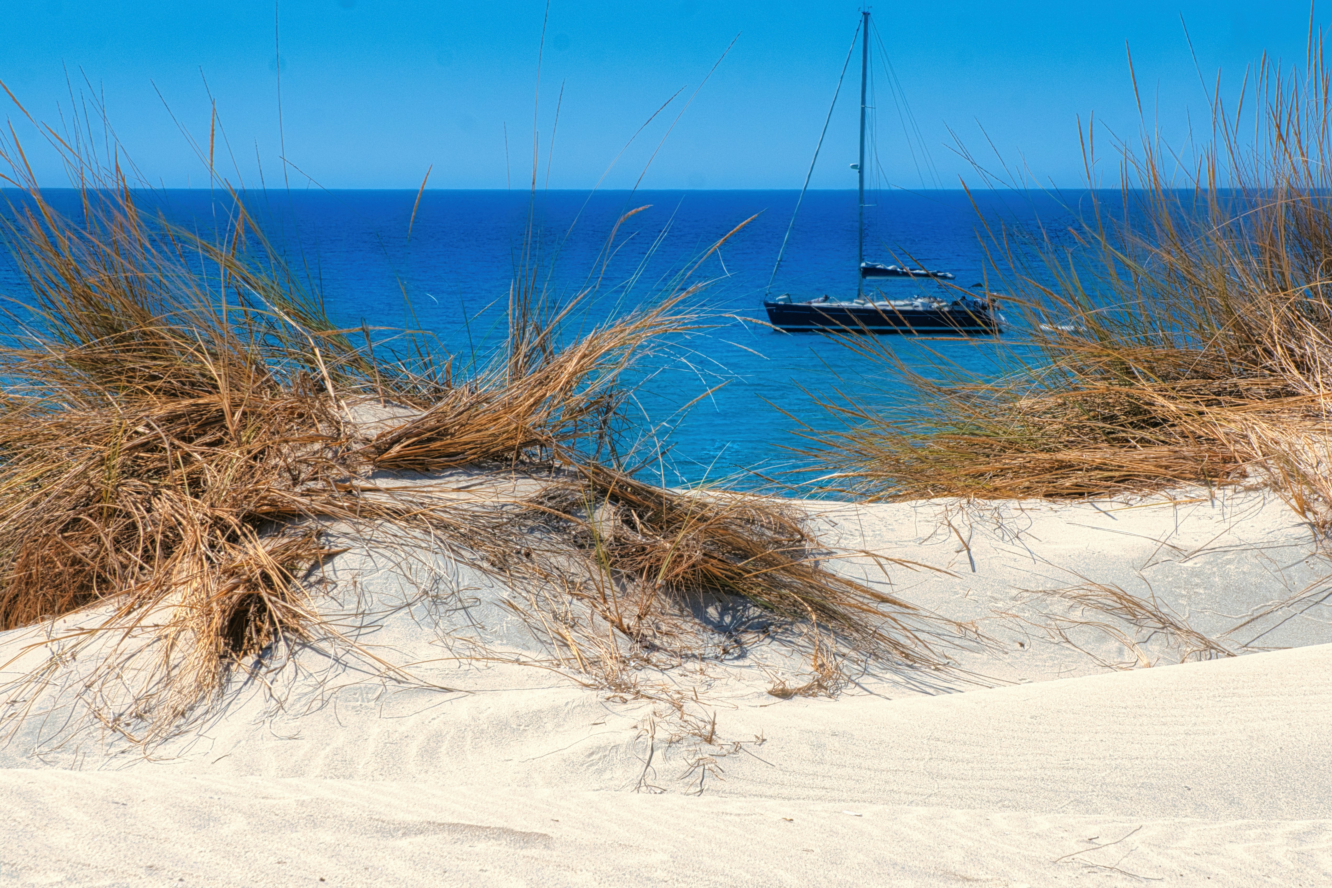 Sailboat Resting Beyond Sea Dunes