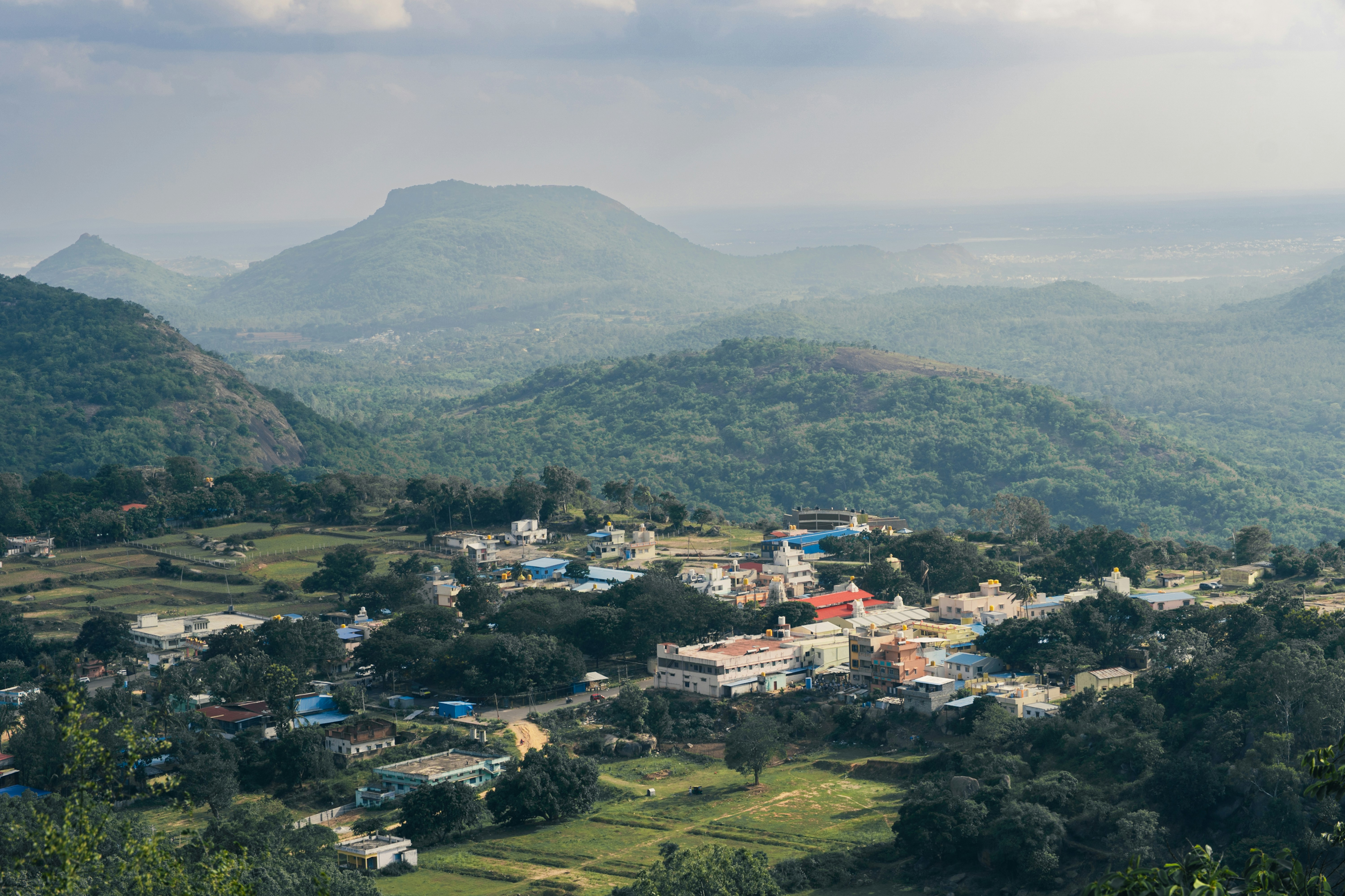 Hidden Village Nestled in the Hills Beneath a Layered Blue Sky