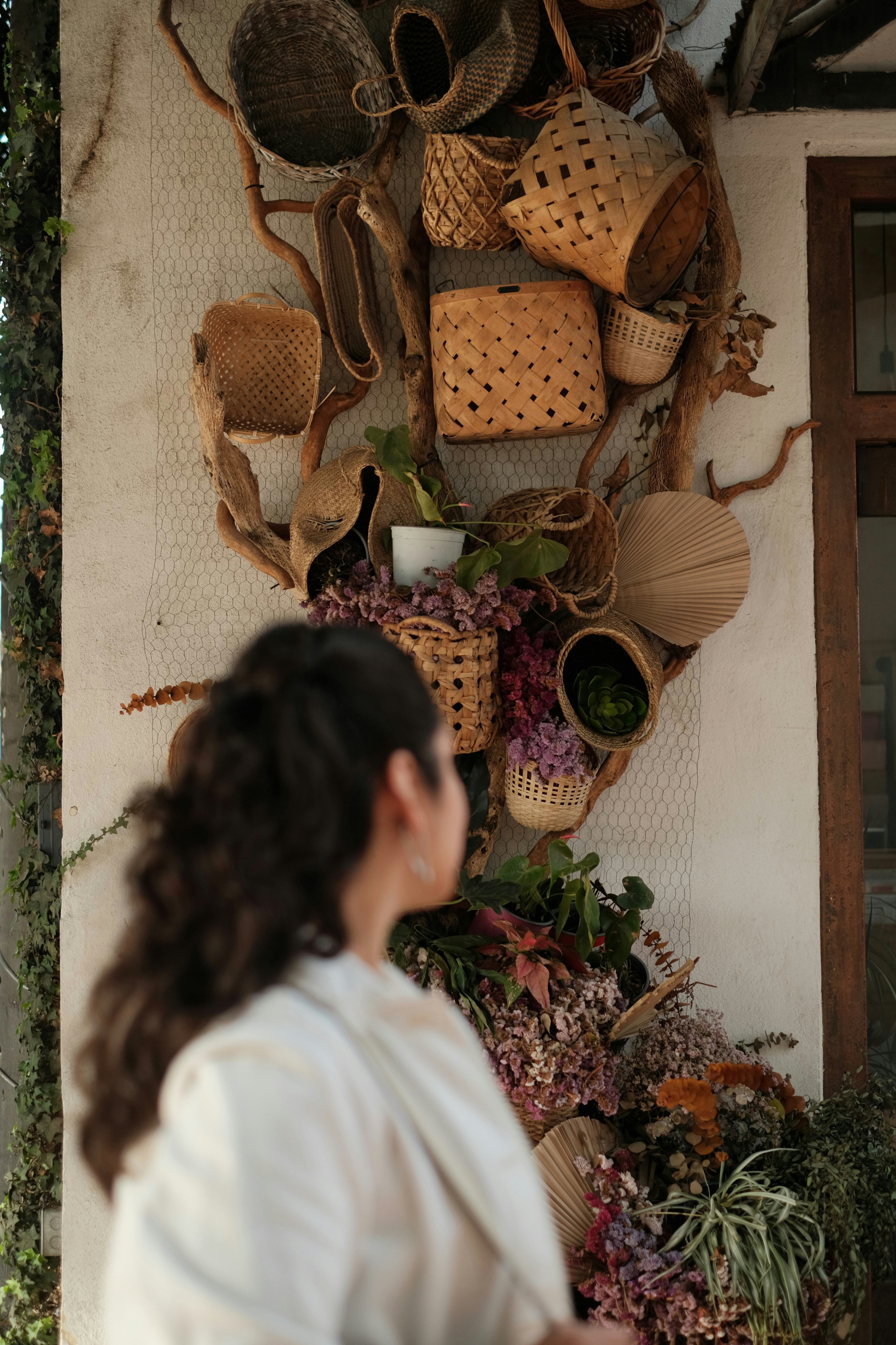 Pastel Bloom Wall: Woven Vessels and a Blurred Portrait